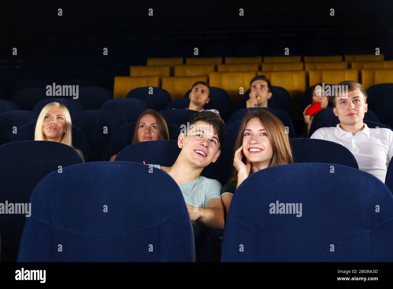 Young people watching movie in cinema Stock Photo - Alamy