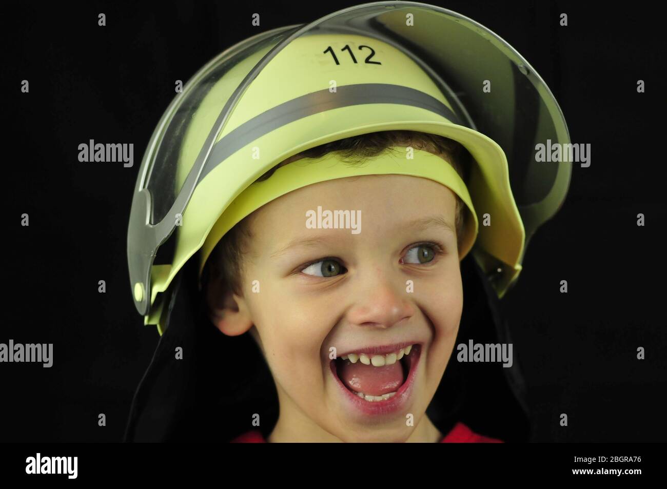 Boy with fire department helmet with the number 112 Stock Photo - Alamy