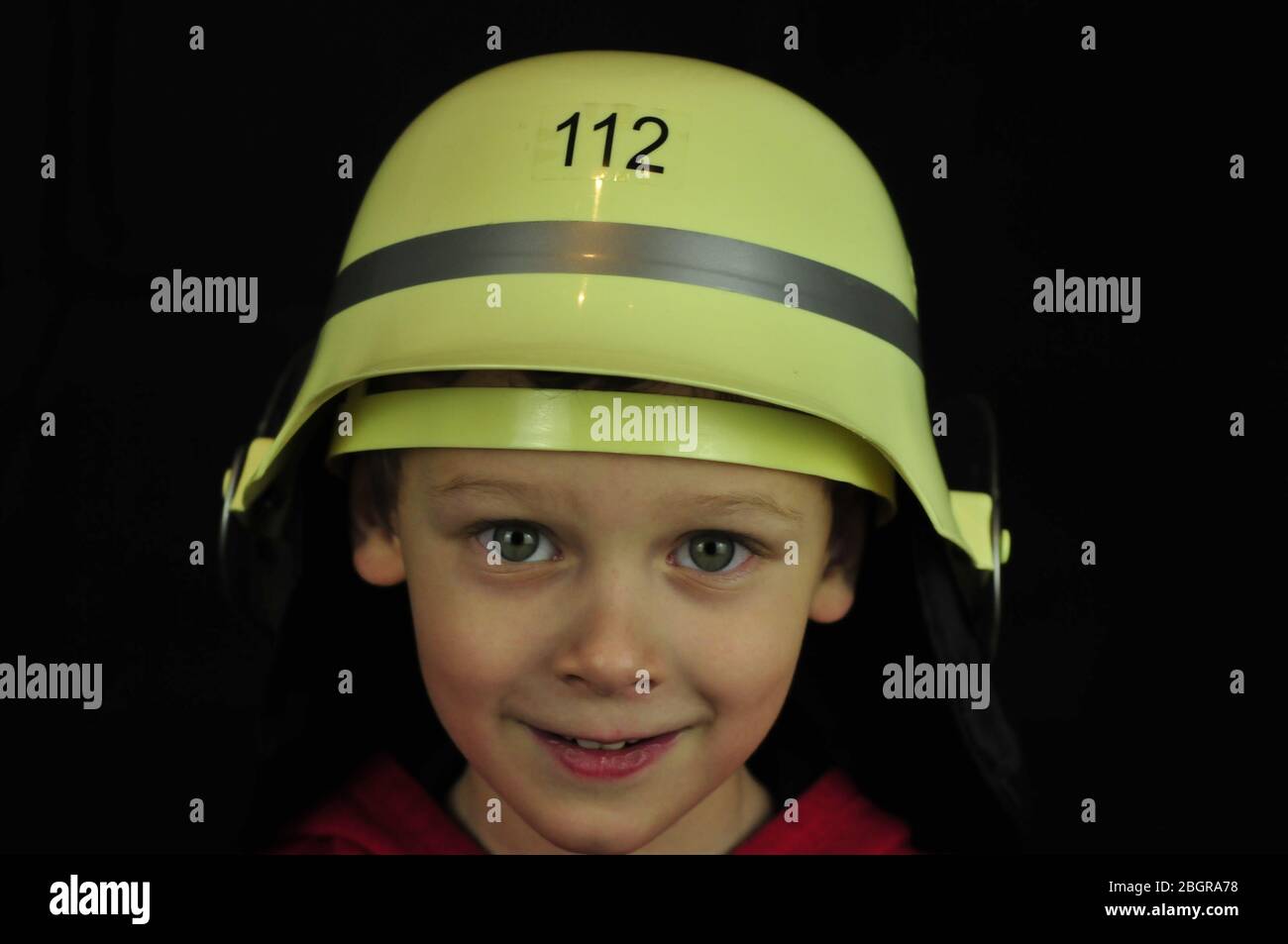 Boy with fire department helmet with the number 112 Stock Photo - Alamy