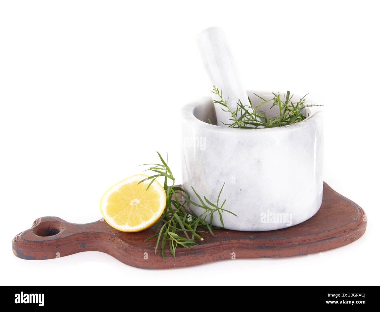 Estragon with lemon in mortar pounder on cutting board isolated on ...