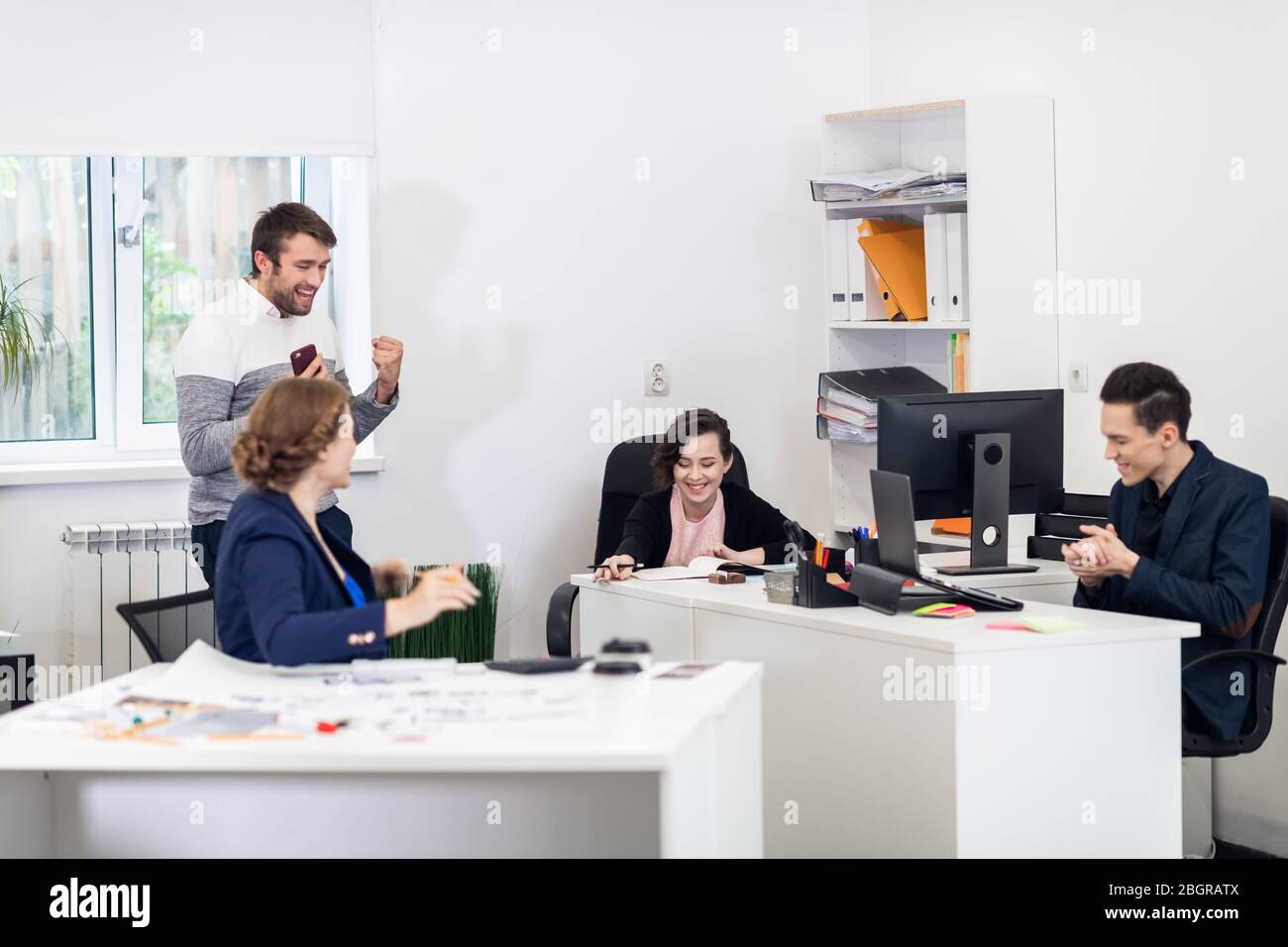 A happy team, who have just received great news over the phone ...