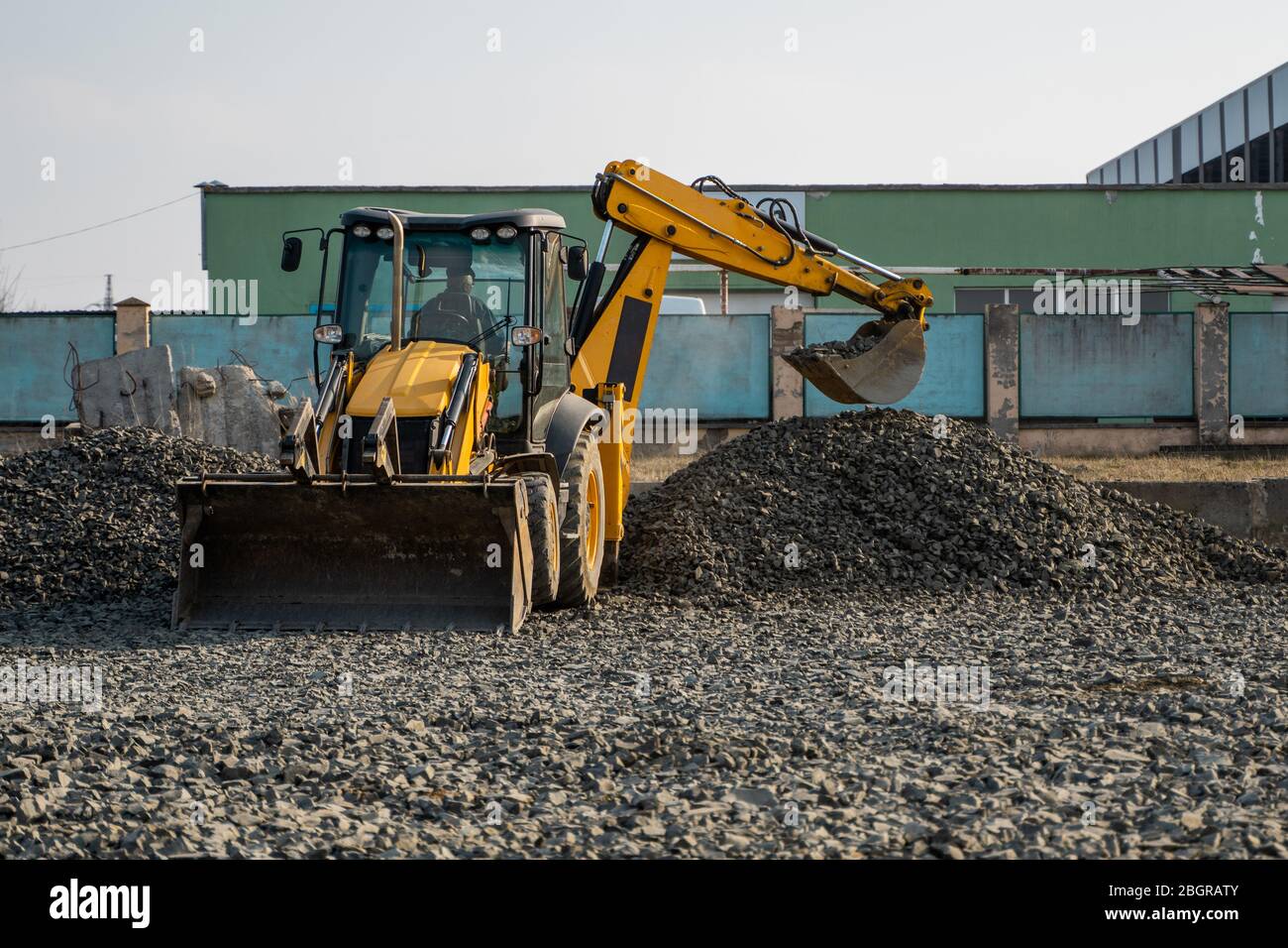 Yellow wheel loader Excavator machine working at construction site with ...