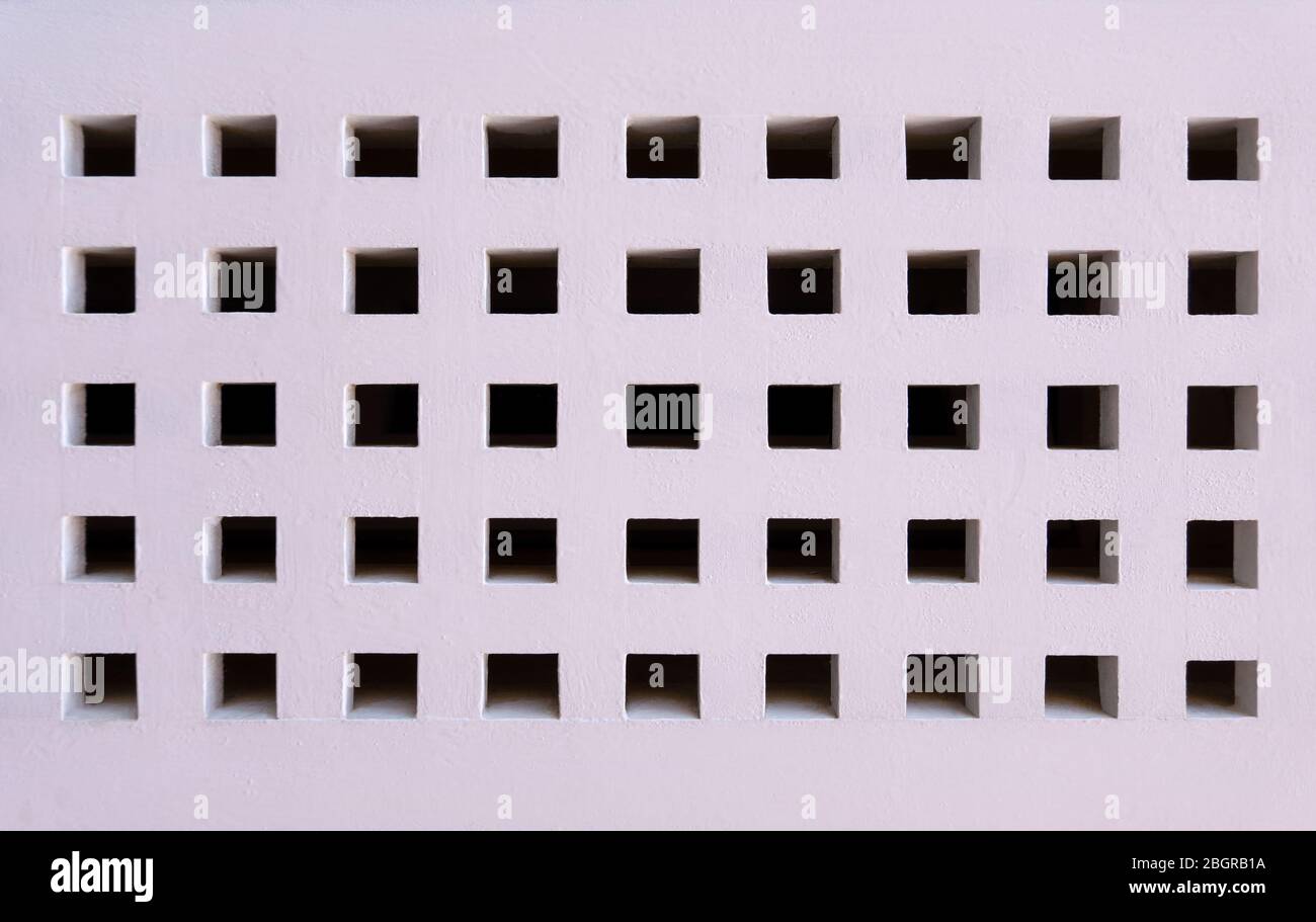 White painted wooden wall with square holes Stock Photo - Alamy