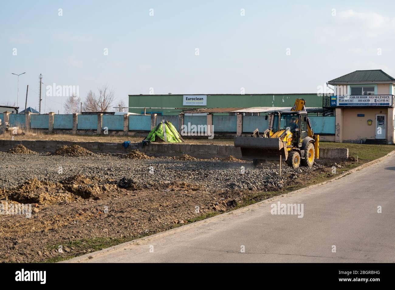 UKRAINE, LUTSK - April 10, 2020: Yellow wheel loader Excavator machine ...