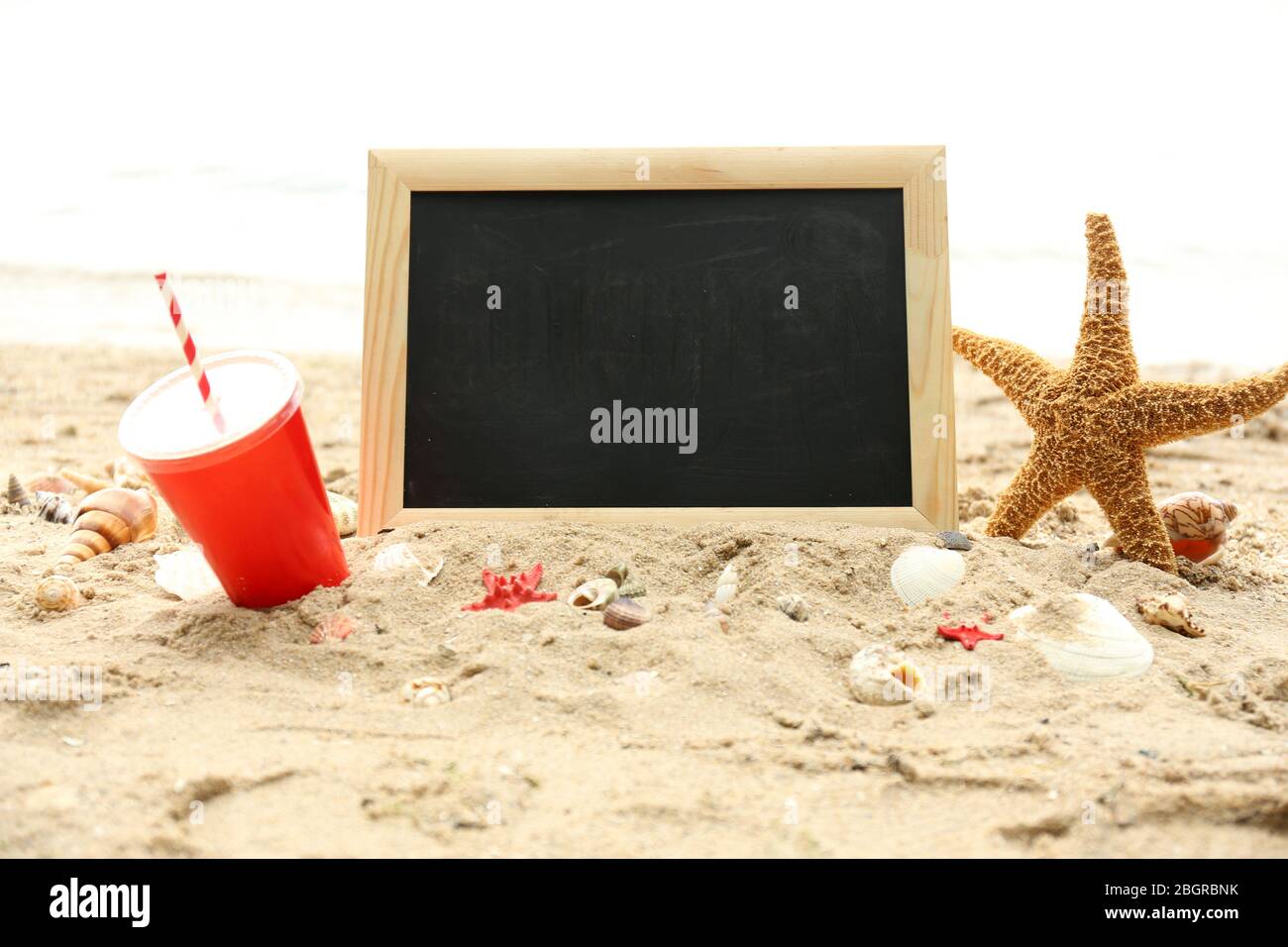 Blank chalkboard on beach background Stock Photo - Alamy