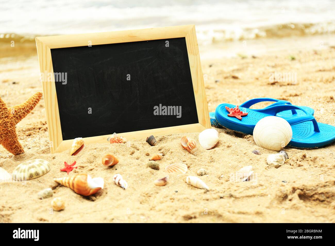 Blank chalkboard on beach background Stock Photo - Alamy