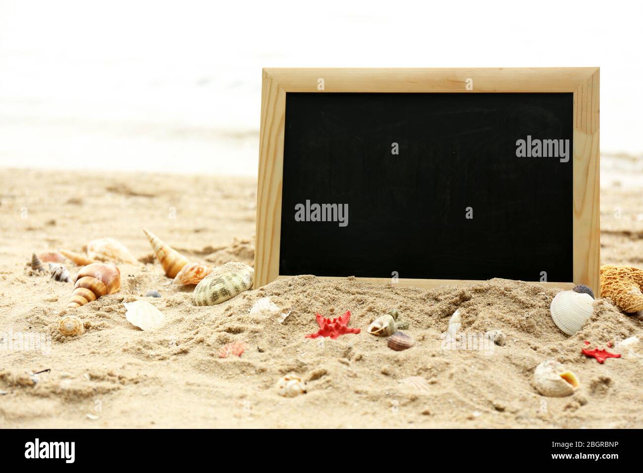 Blank chalkboard on beach background Stock Photo - Alamy