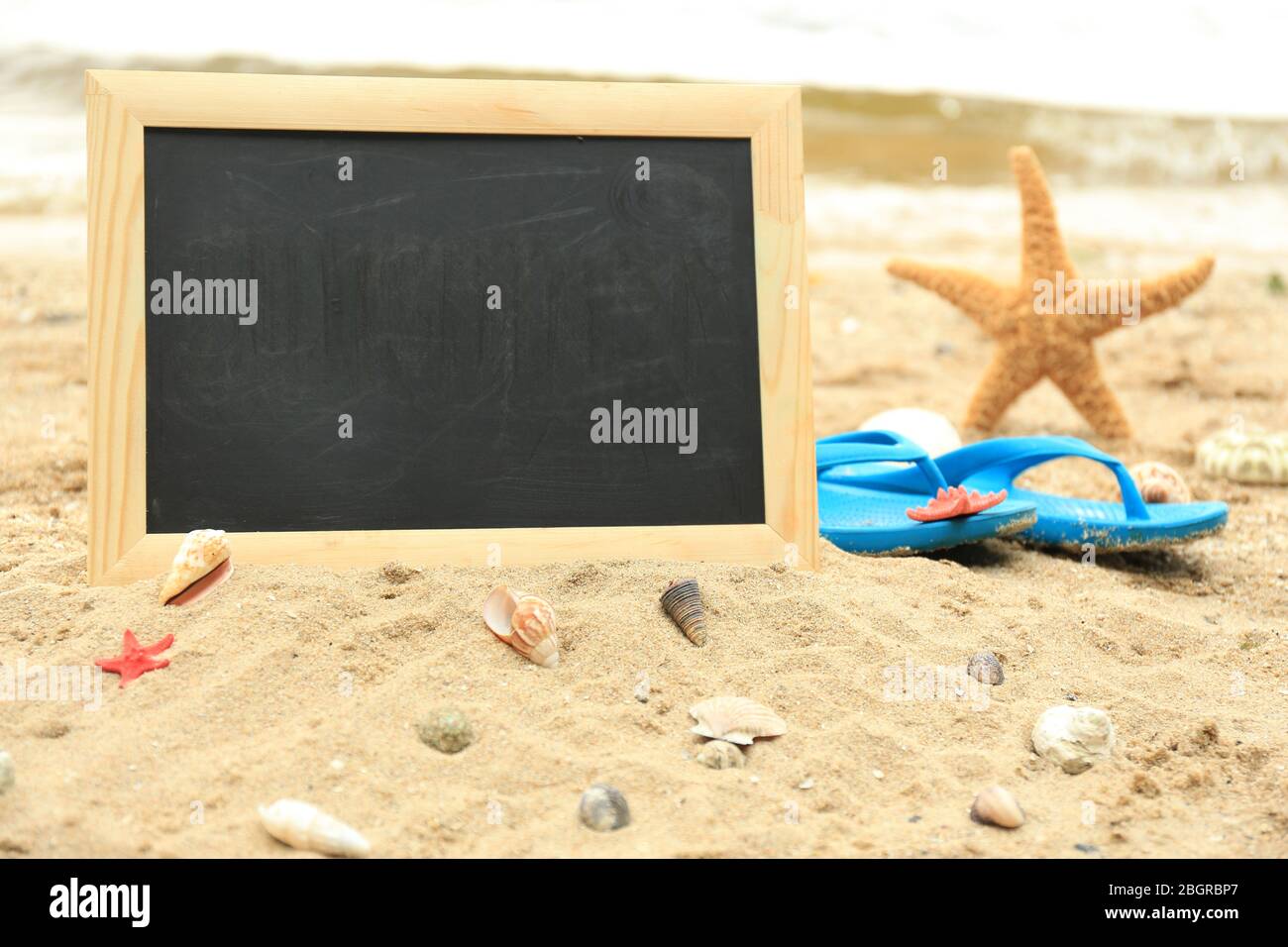 Blank chalkboard on beach background Stock Photo - Alamy