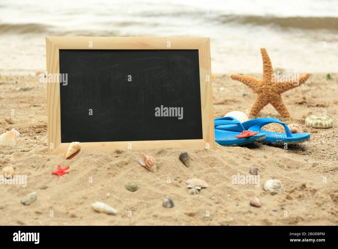 Blank chalkboard on beach background Stock Photo - Alamy