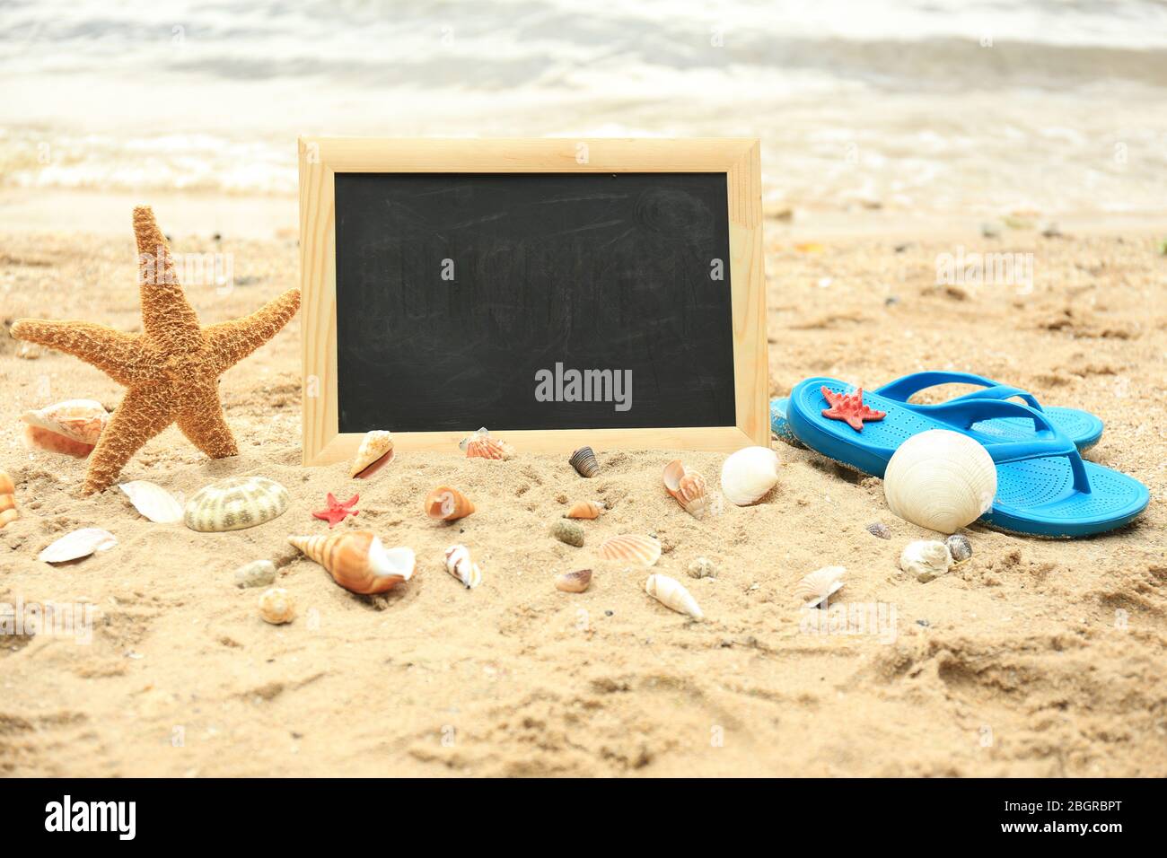 Blank chalkboard on beach background Stock Photo - Alamy