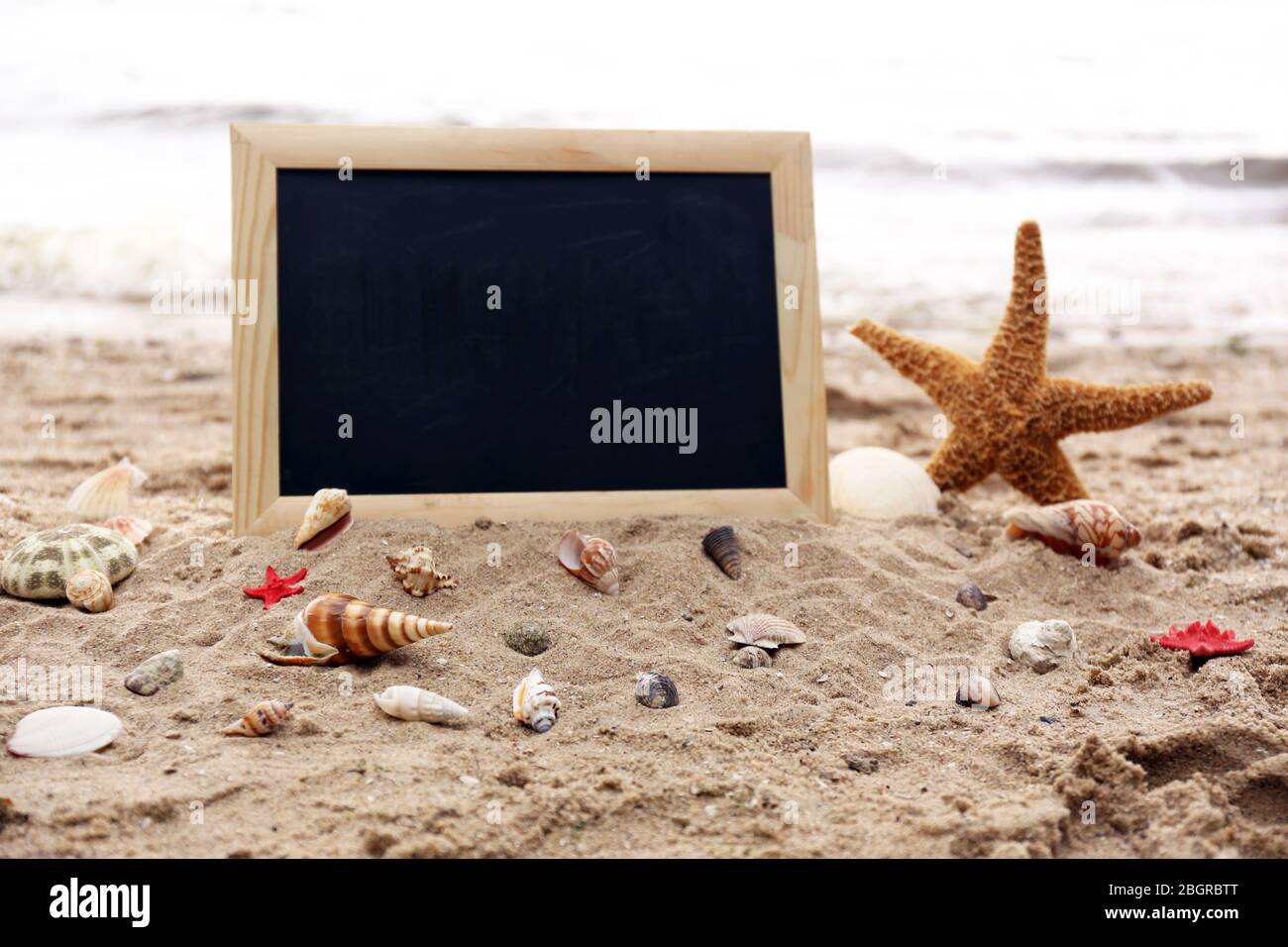 Blank chalkboard on beach background Stock Photo - Alamy