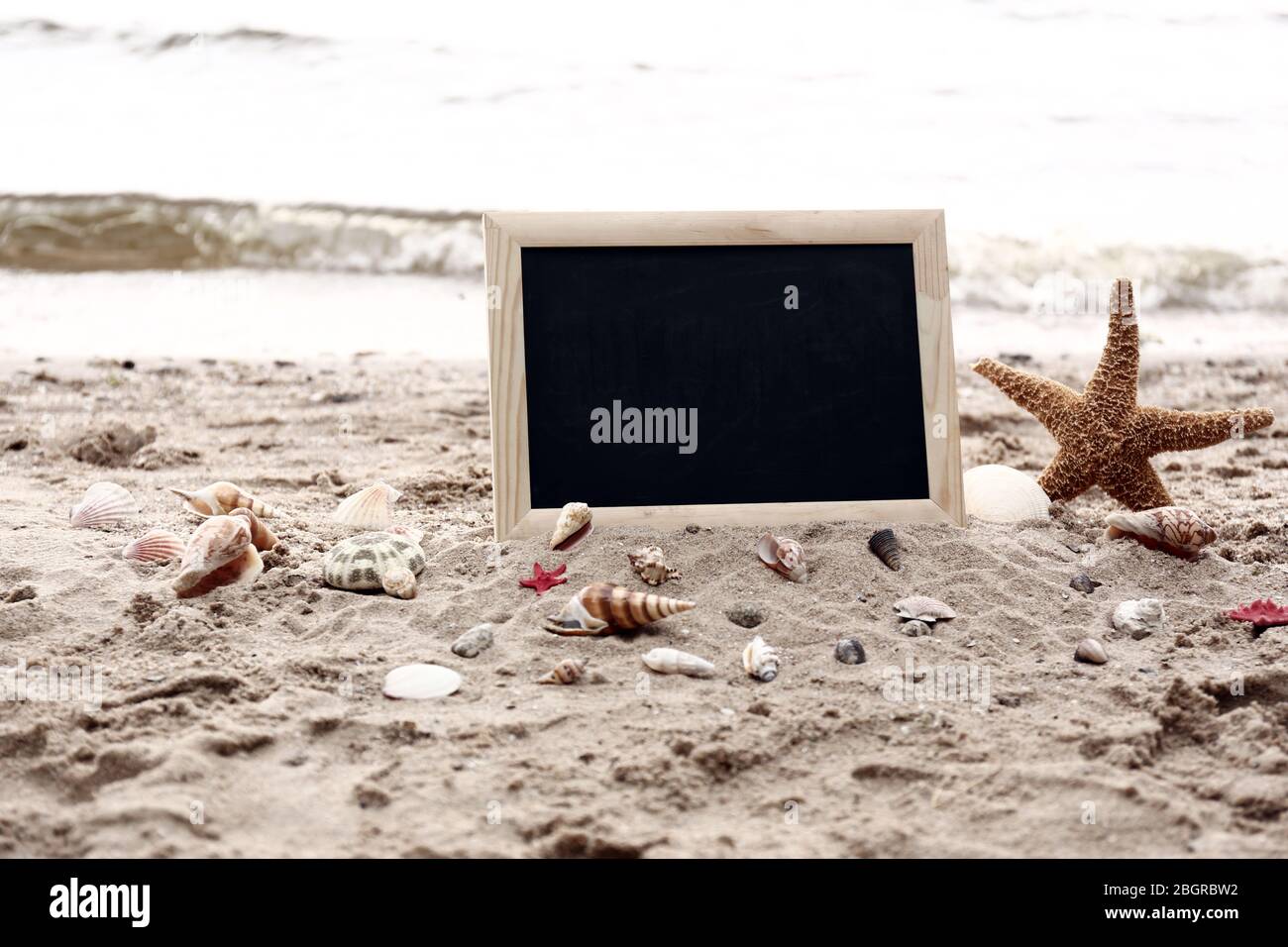 Blank chalkboard on beach background Stock Photo - Alamy