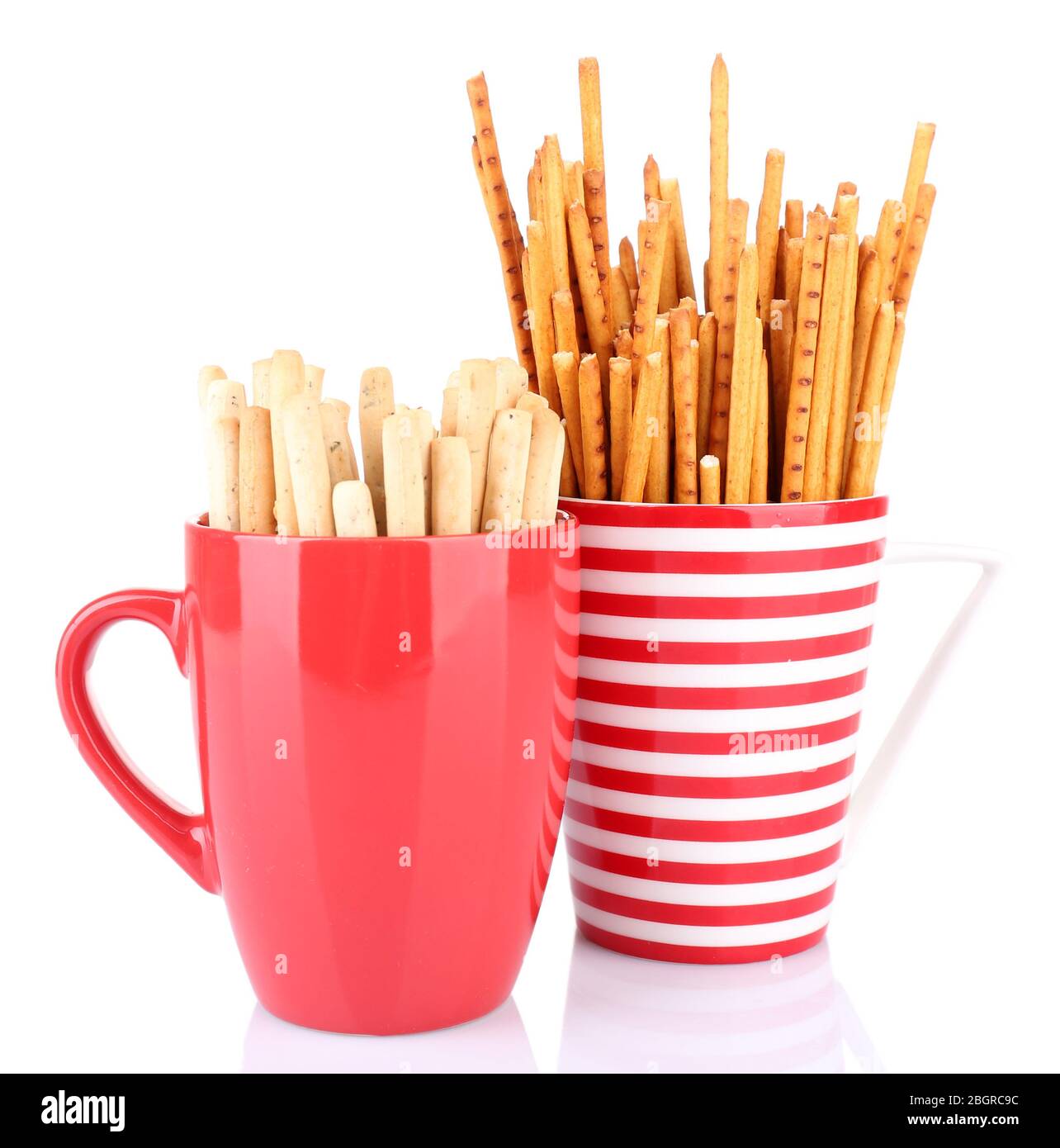 Sticks in red cups on white background isolated Stock Photo - Alamy