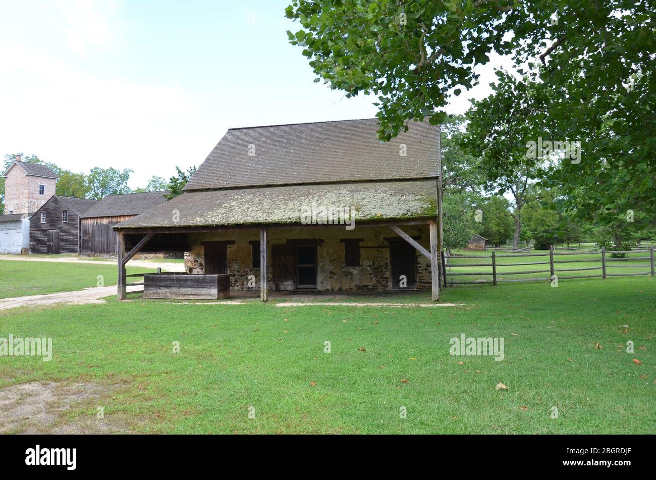 brick building with moss on roof with green grass or lawn Stock Photo ...