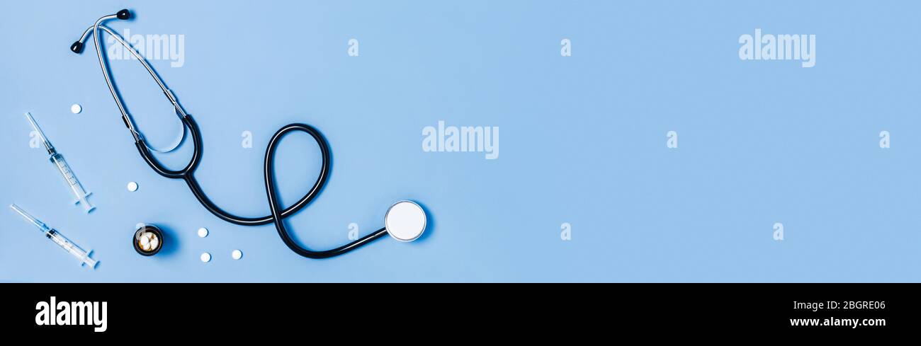 Medical blue background with stethoscope, thermometer, syringe and ...