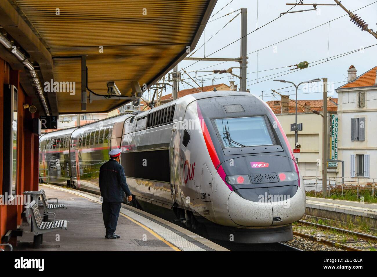 ST RAPHAEL, FRANCE - APRIL 2019: Railway worker on the platform as a ...