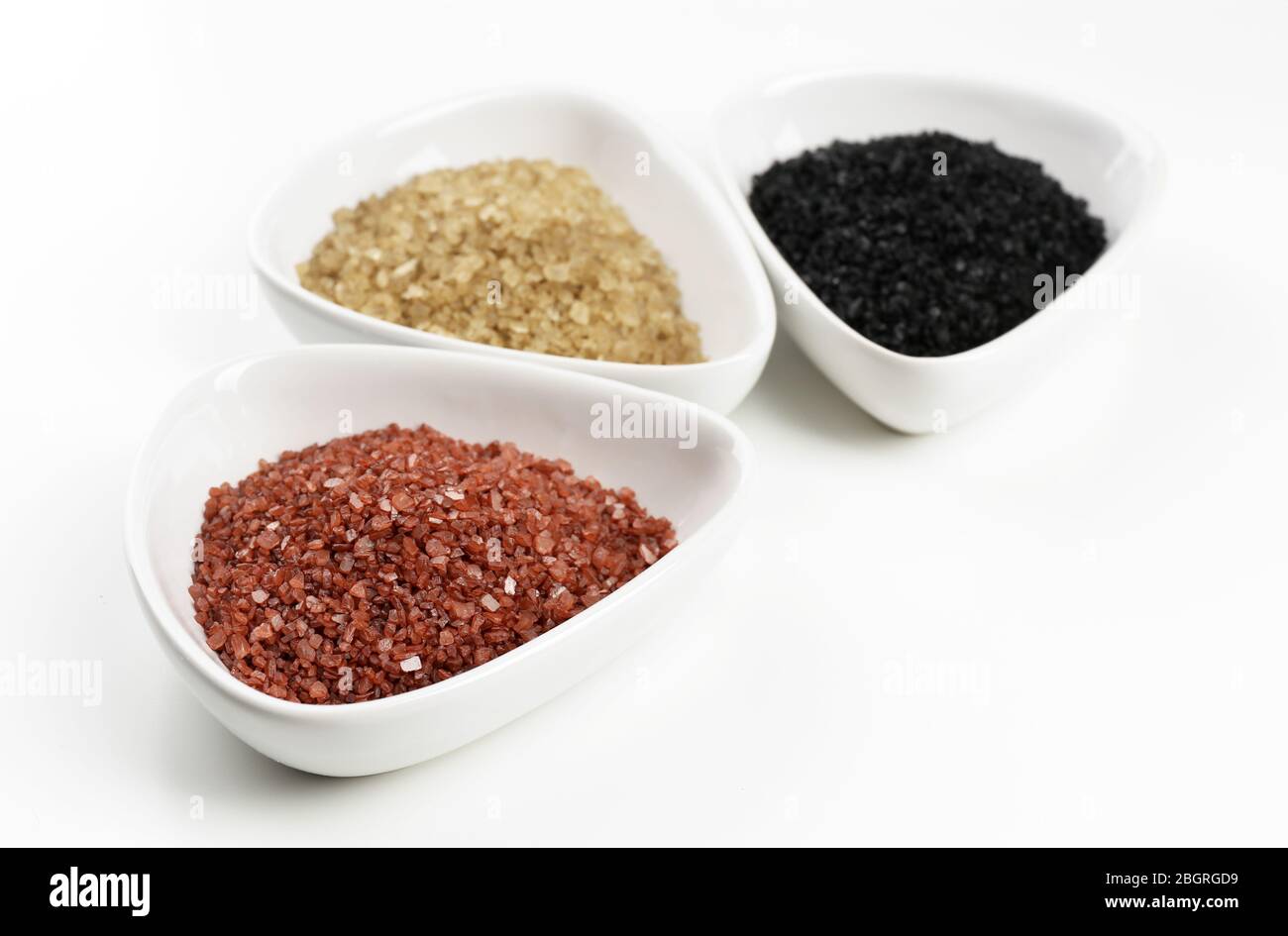 Different sea salt in bowls isolated on white Stock Photo - Alamy