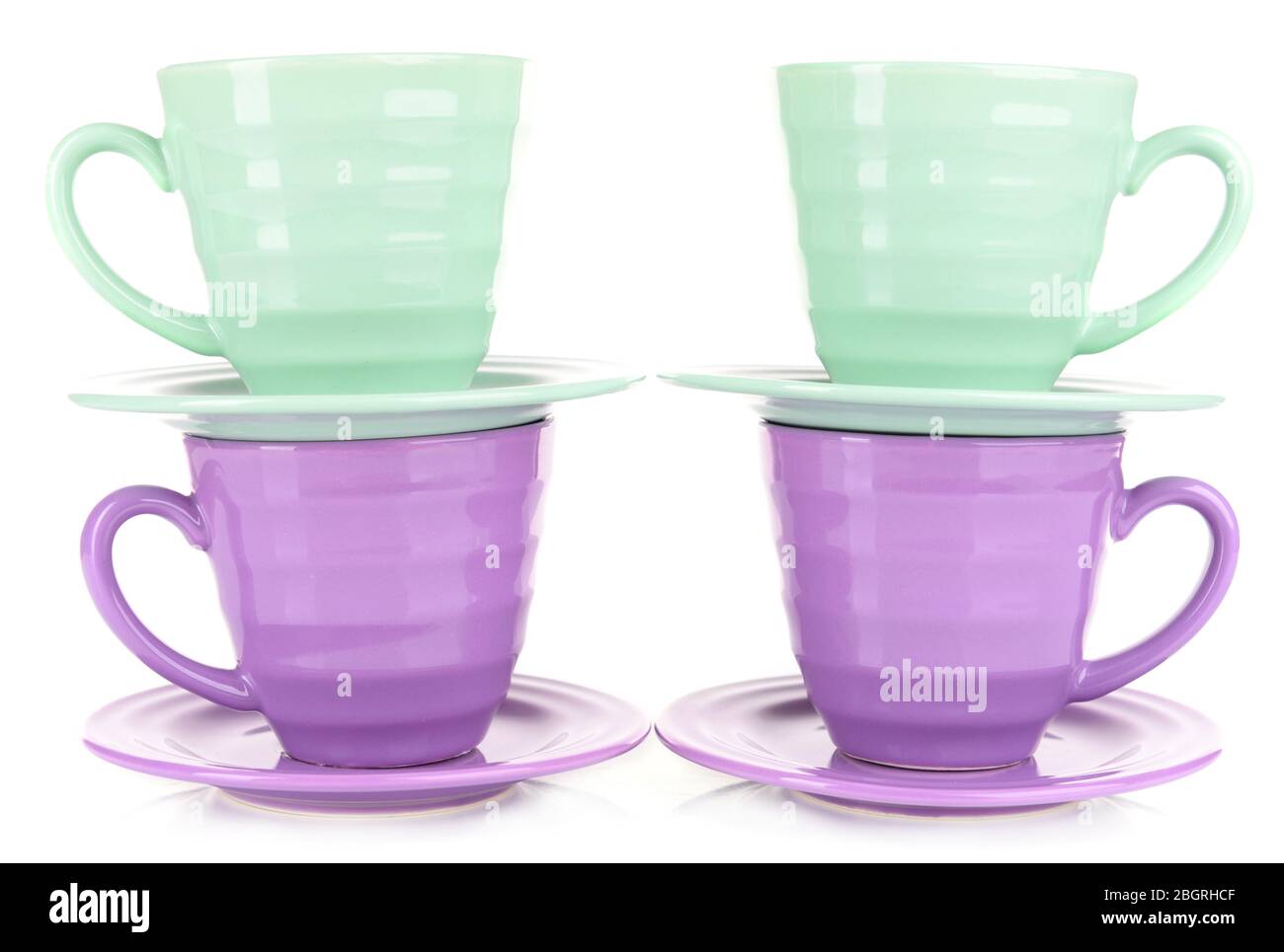 Bright cups and saucers isolated on white Stock Photo - Alamy