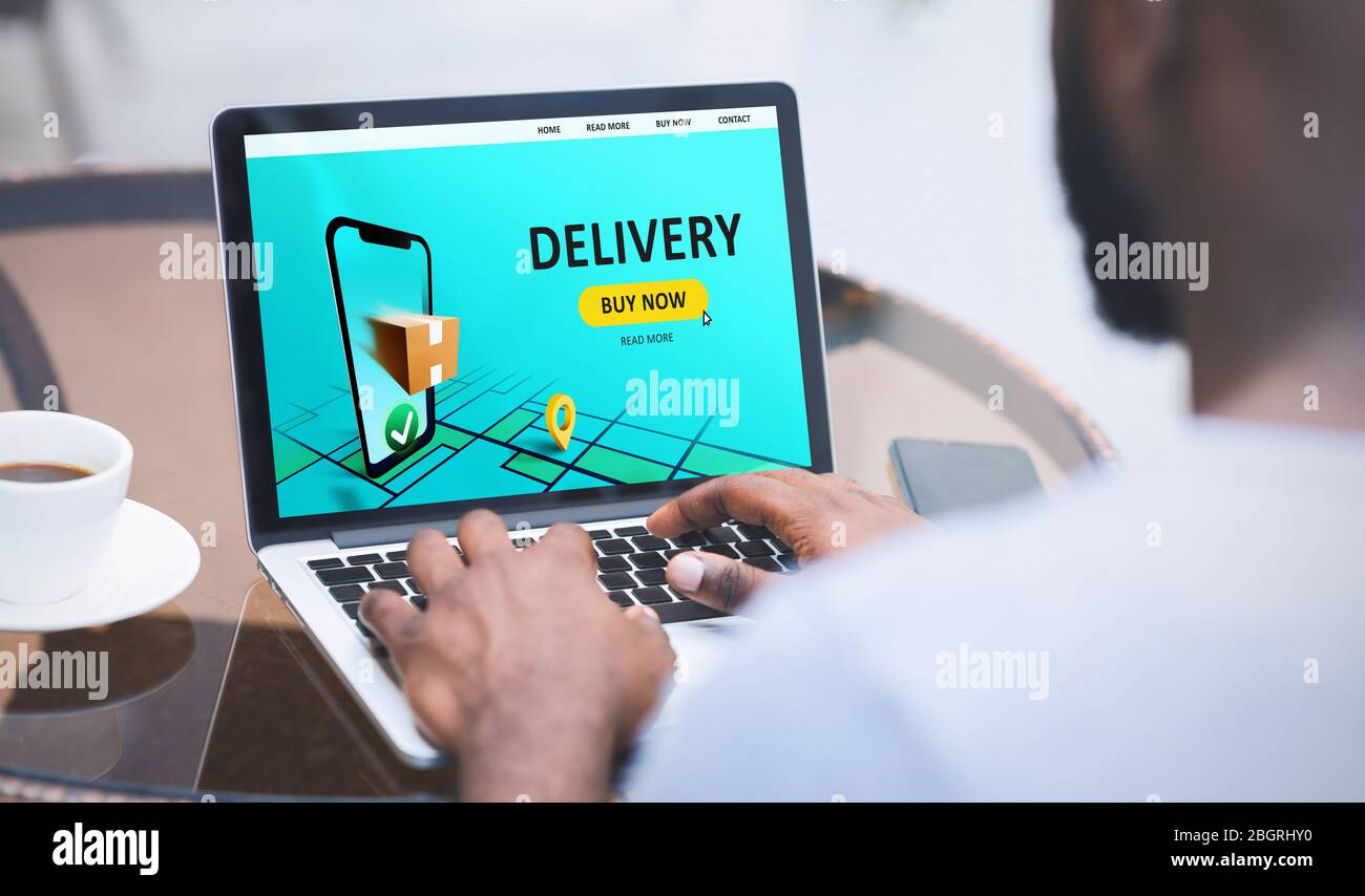 Internet shopping and delivery service. Black guy with laptop ordering ...