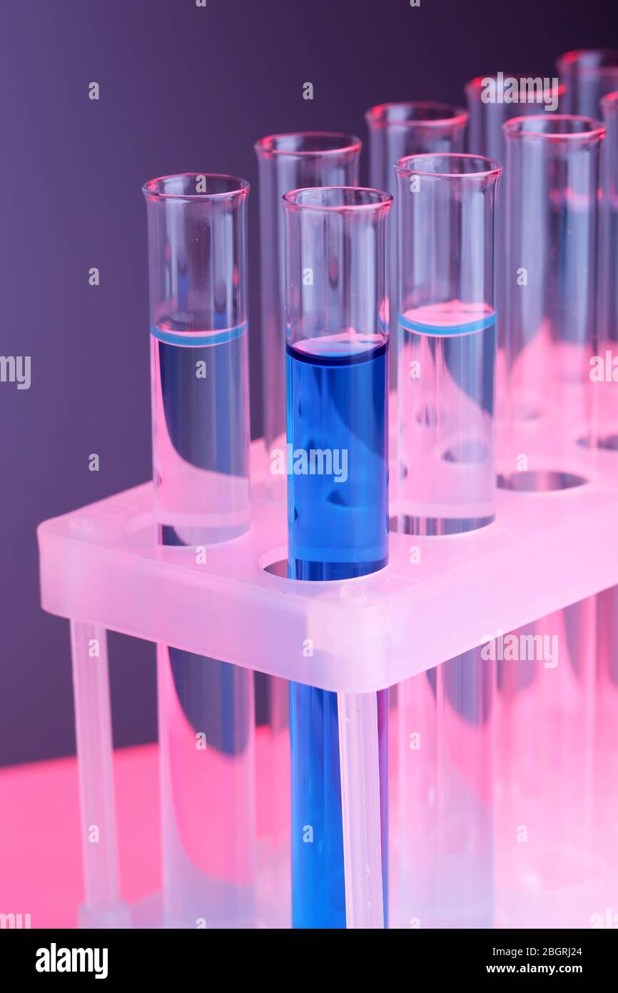 Test tubes with blue liquid on dark background Stock Photo - Alamy