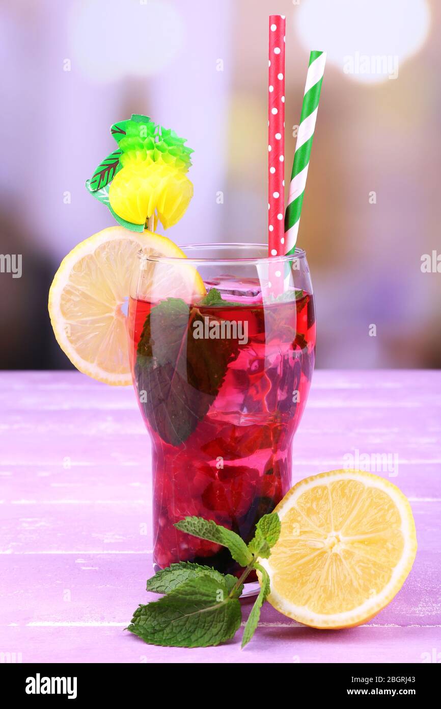 Glass of cold berry cocktail with lemon on wooden table Stock Photo - Alamy
