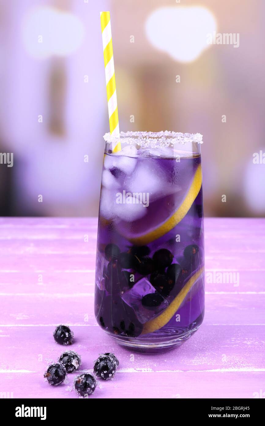 Glass of cold berry cocktail on wooden table Stock Photo - Alamy