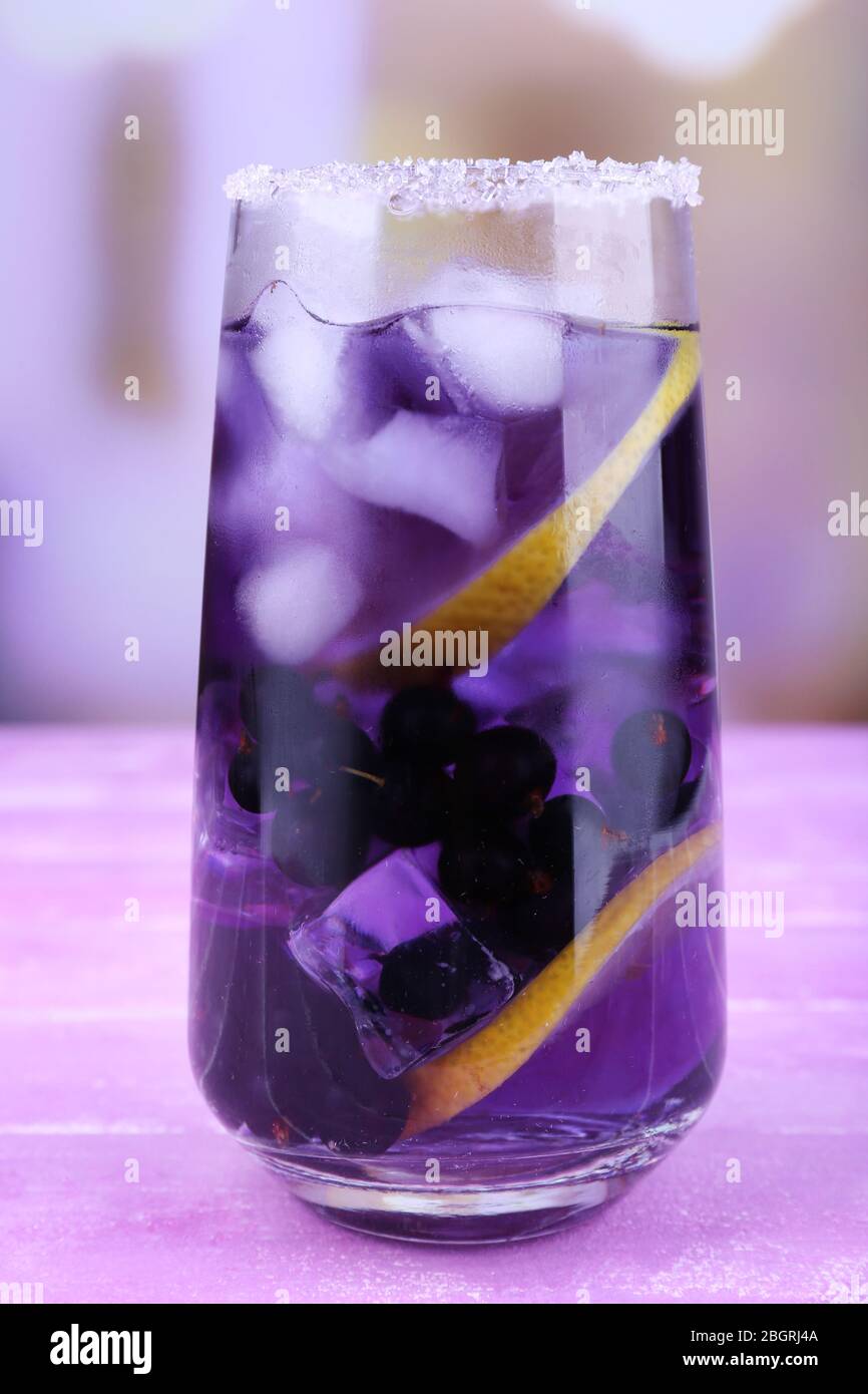 Glass of cold berry cocktail on wooden table Stock Photo - Alamy