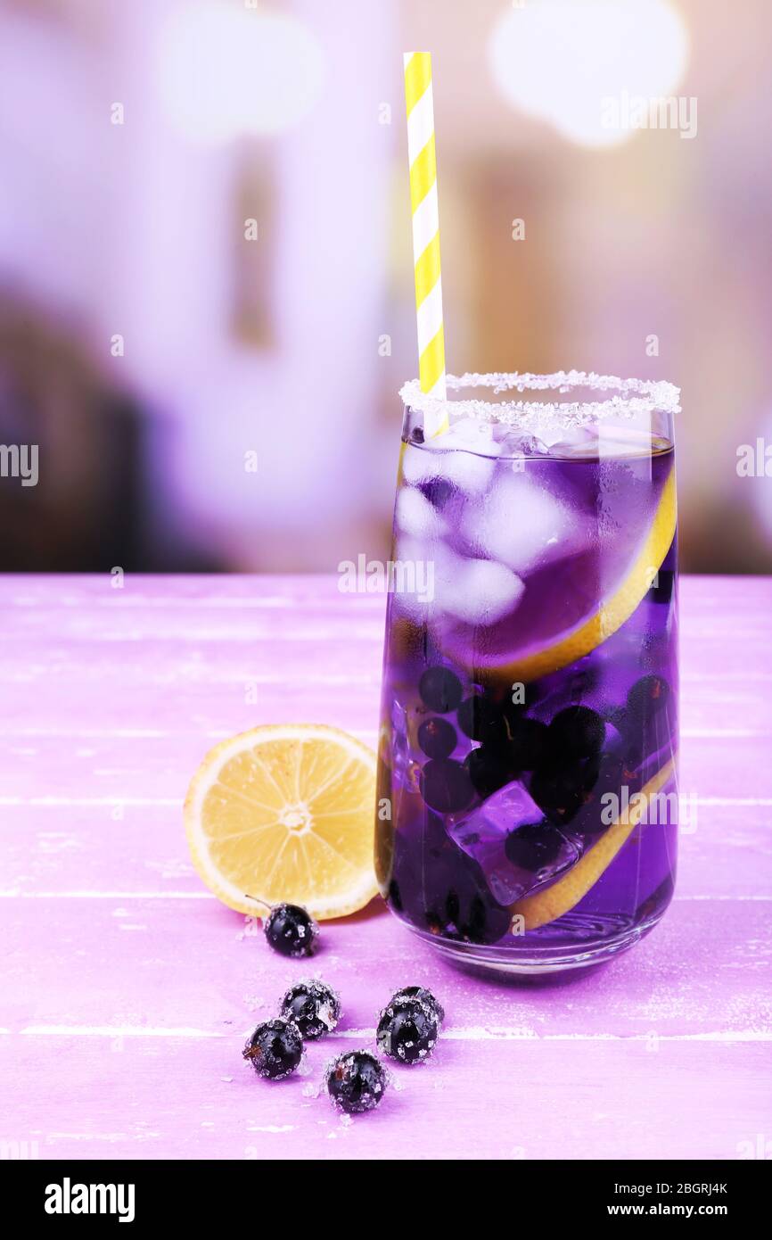 Glass of cold berry cocktail with lemon on wooden table Stock Photo - Alamy