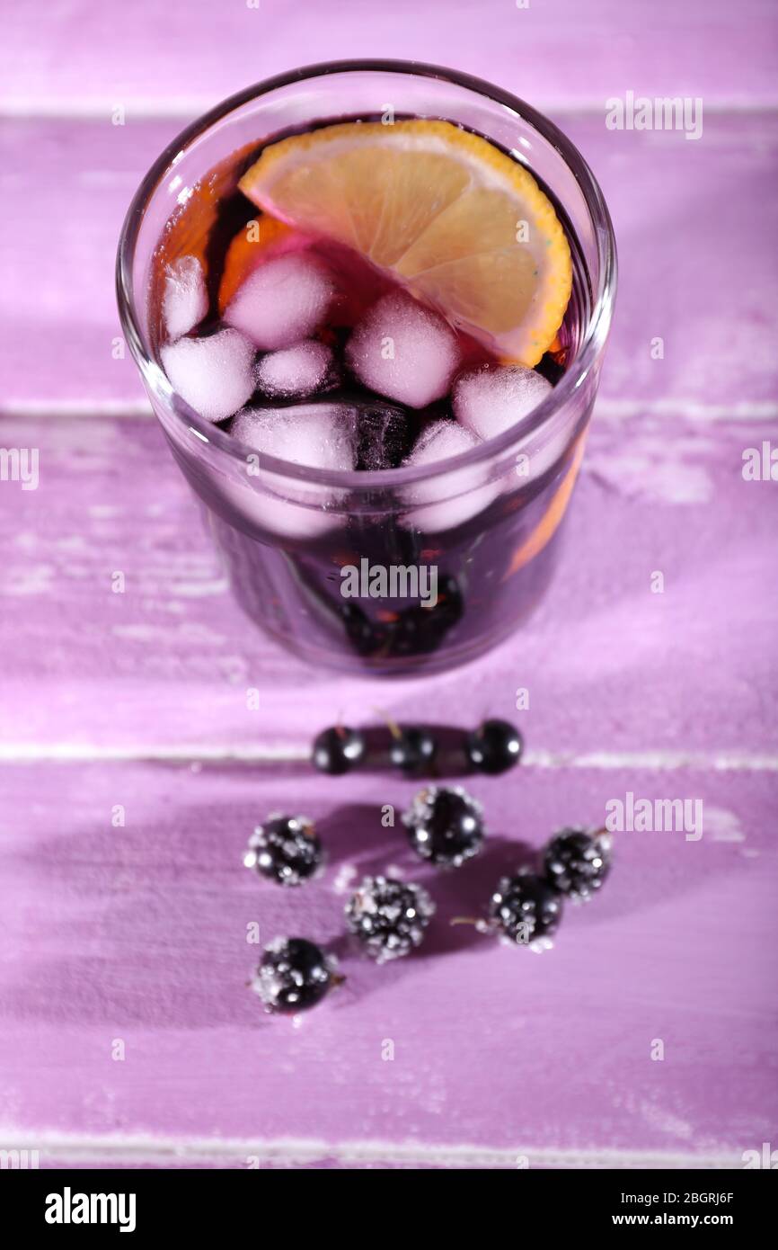 Glass of cold berry cocktail on wooden background Stock Photo - Alamy