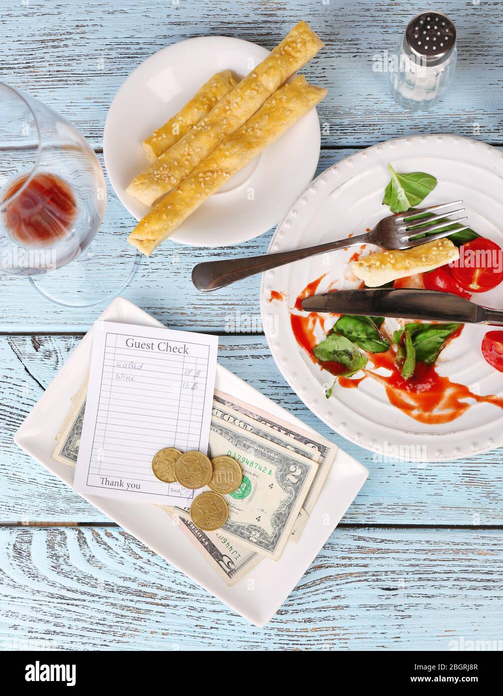 Check and remnants of food on table in restaurant Stock Photo - Alamy