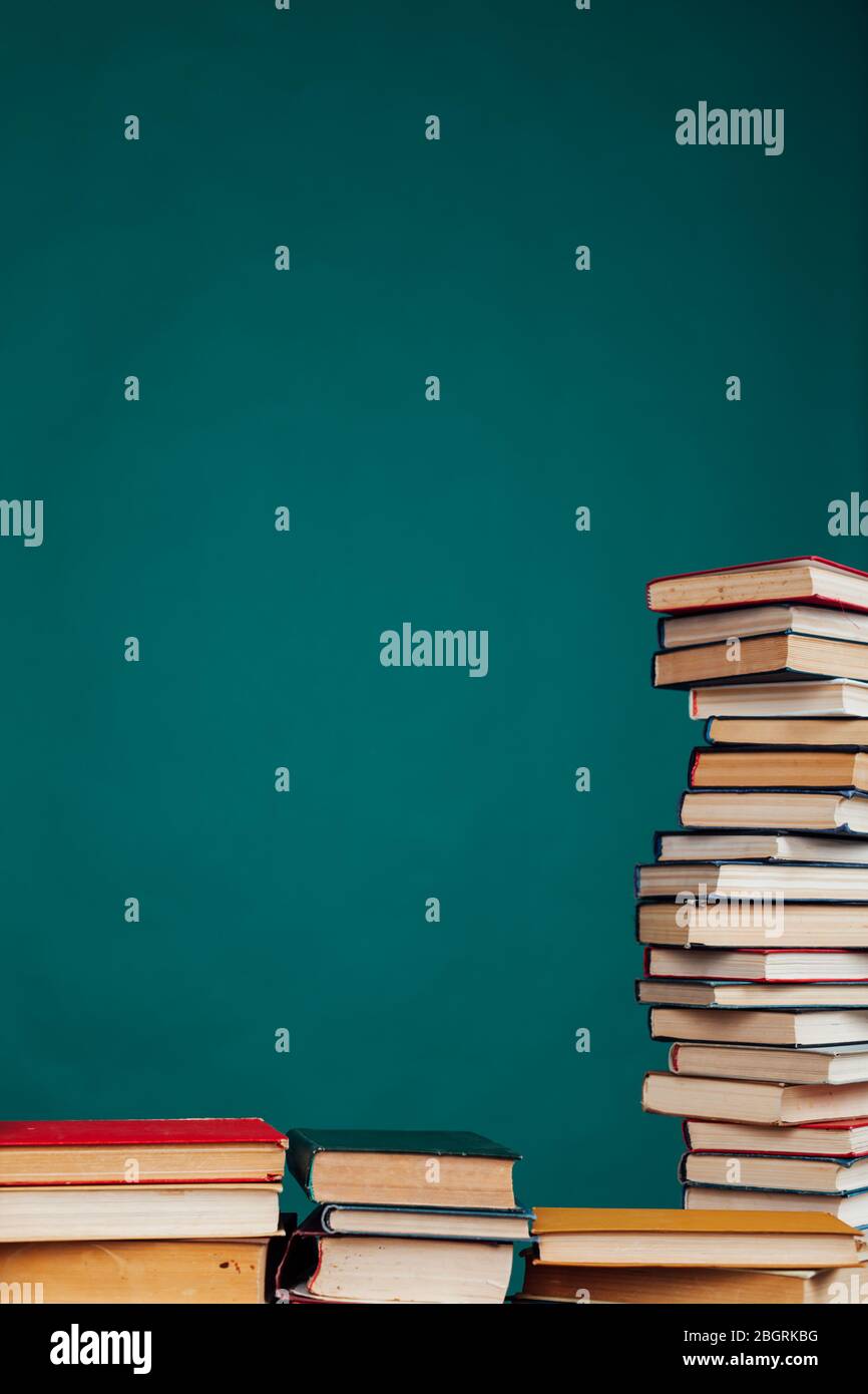 many stacks of educational books in the university library on a green ...
