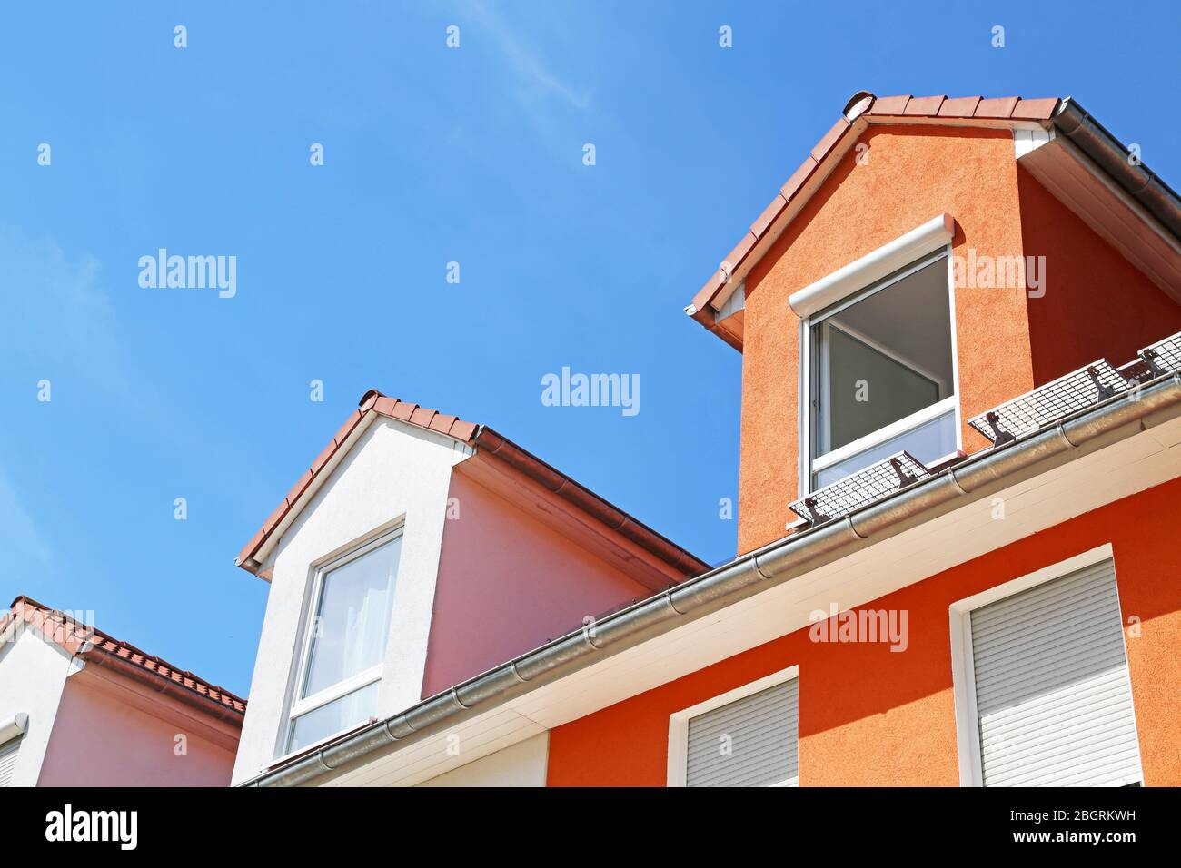 gable dormer on colored townhouses Stock Photo - Alamy