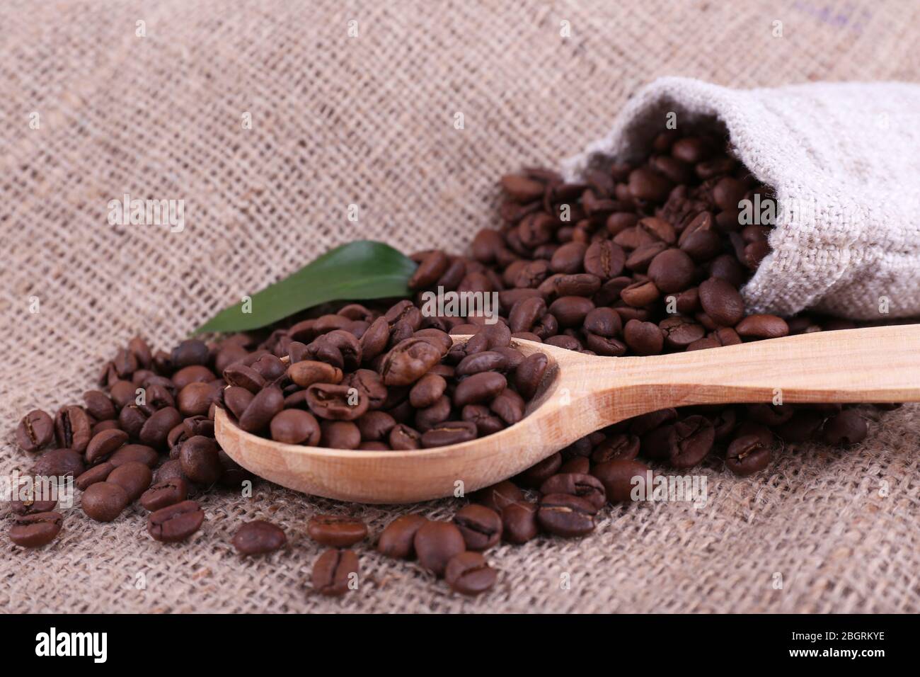 Coffee beans on sacking background Stock Photo - Alamy