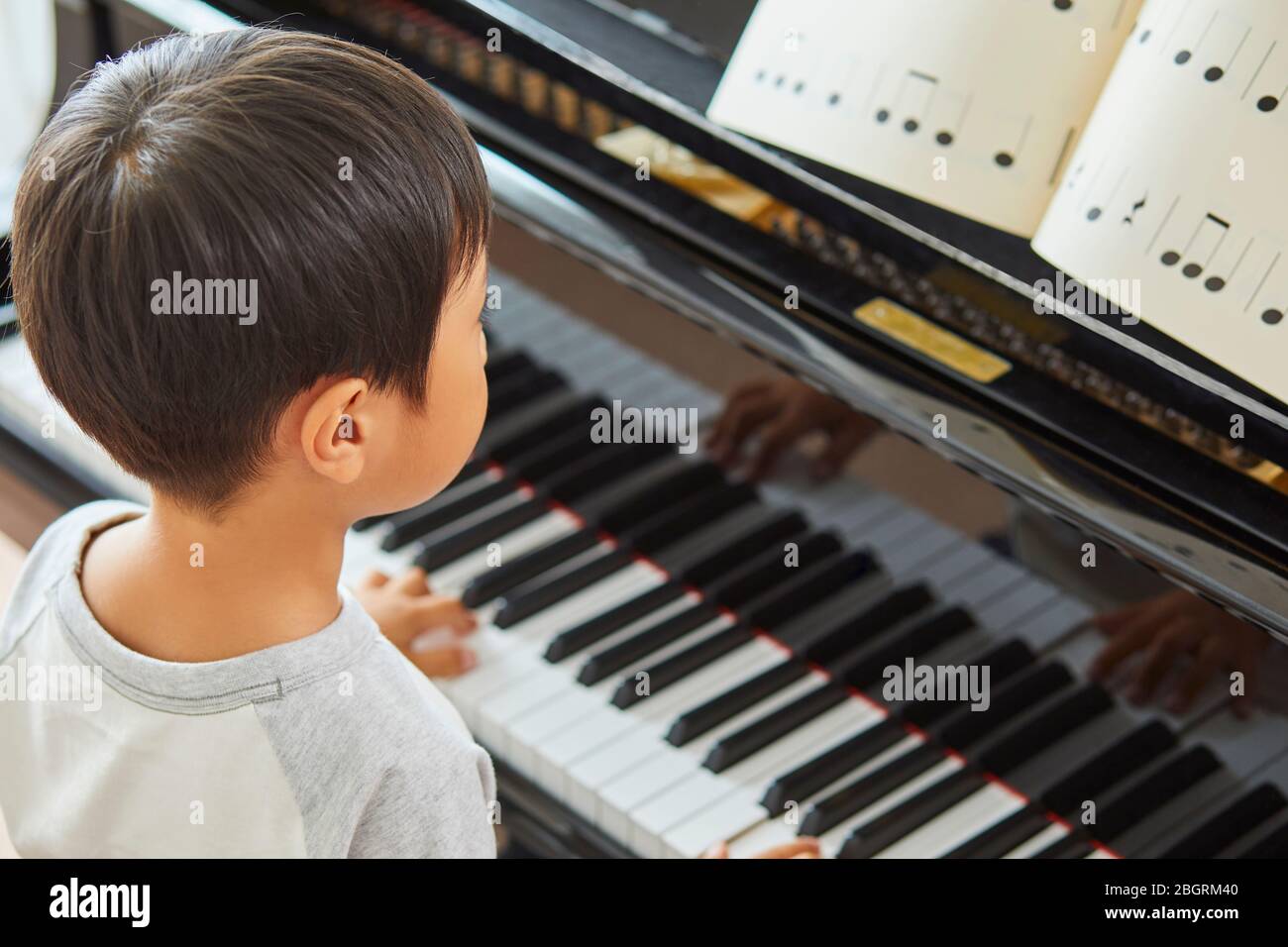 Kid piano back view hi-res stock photography and images - Alamy