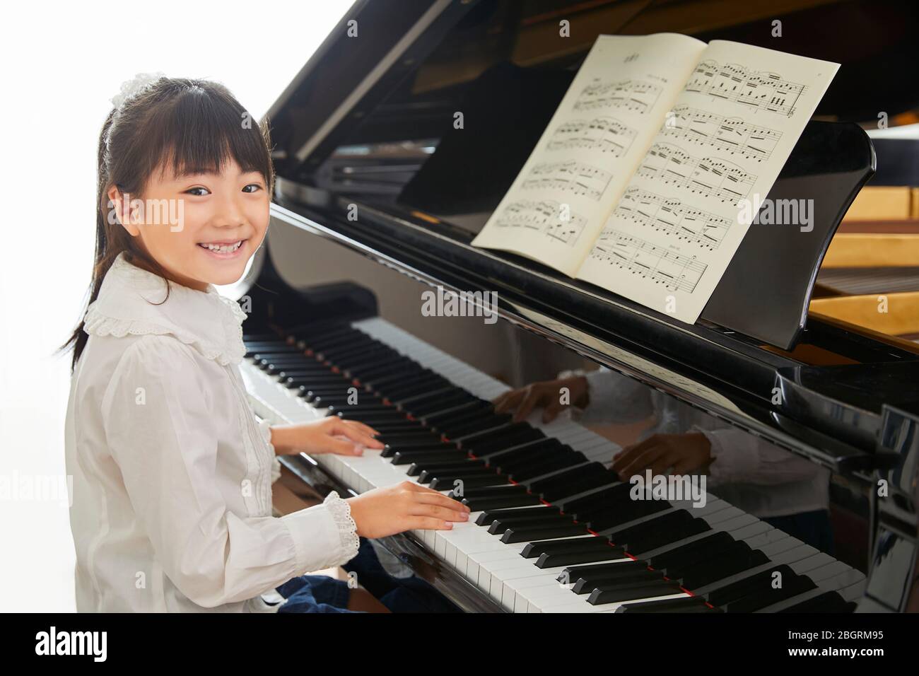 Japanese kid practicing piano Stock Photo - Alamy