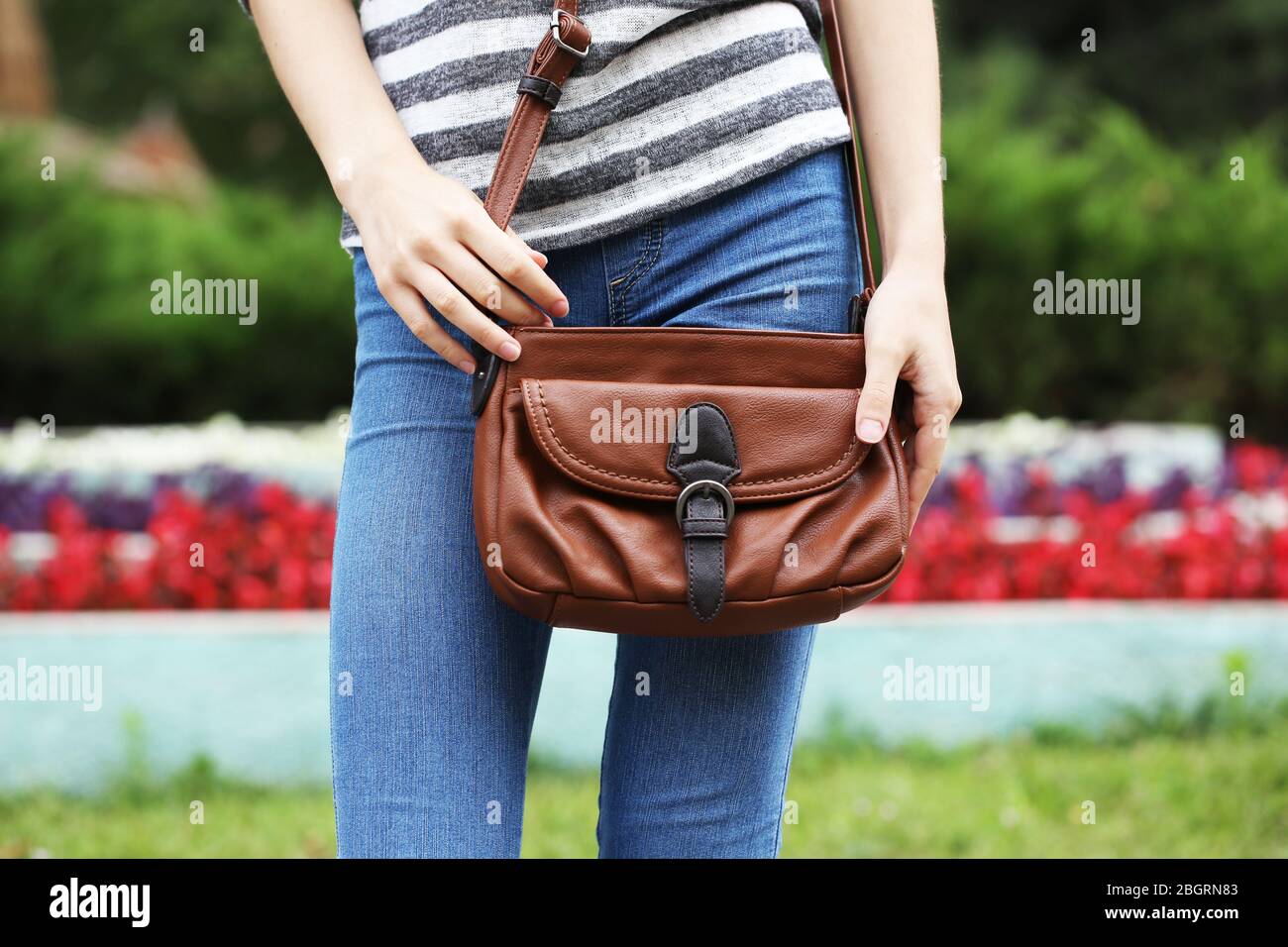 Girl with bag over his shoulder outdoors Stock Photo - Alamy