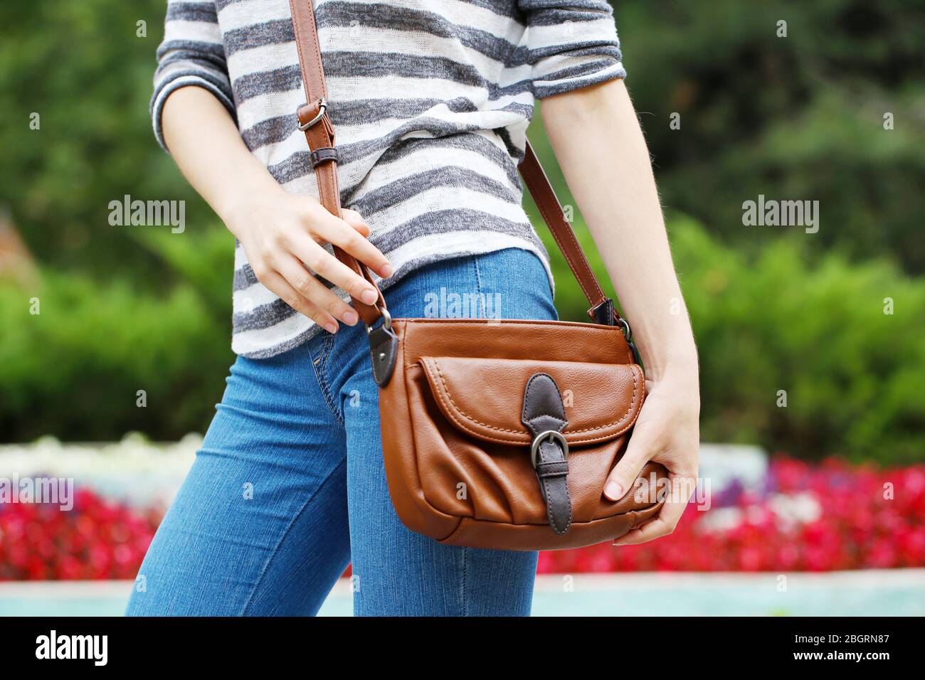 Girl with bag over his shoulder outdoors Stock Photo - Alamy