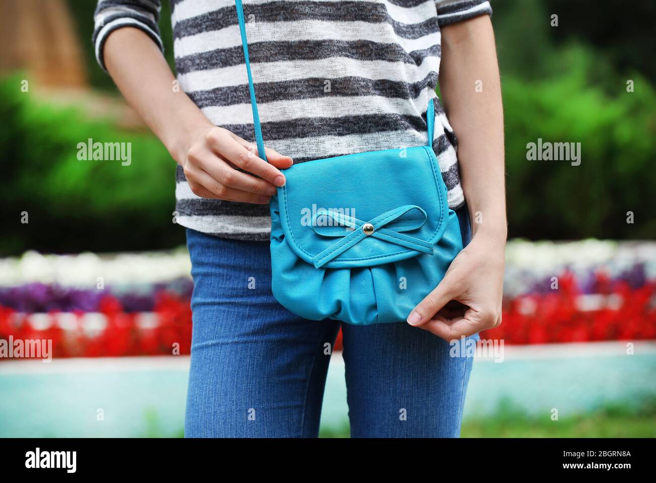 Girl with bag over his shoulder outdoors Stock Photo - Alamy