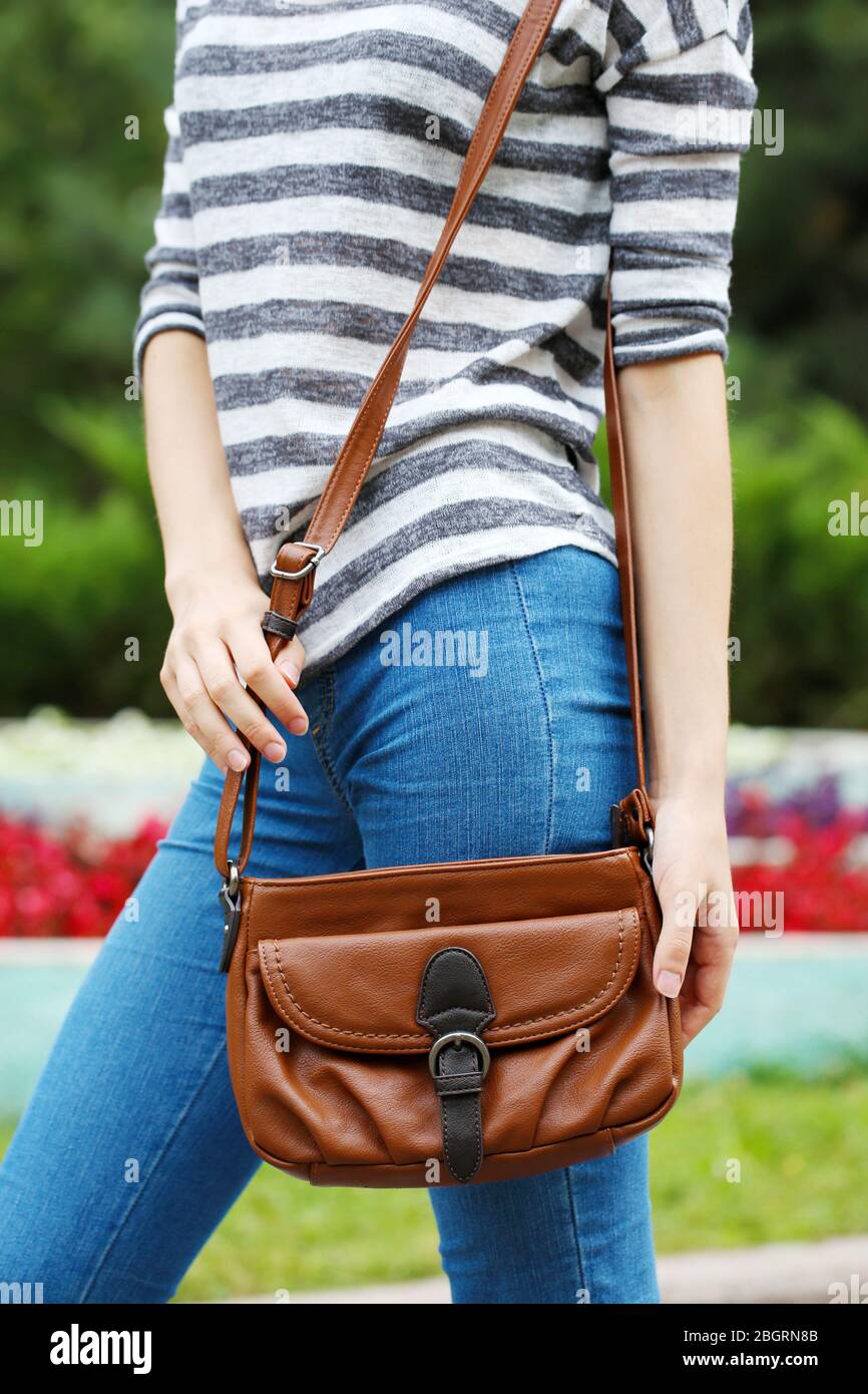 Girl with bag over his shoulder outdoors Stock Photo - Alamy