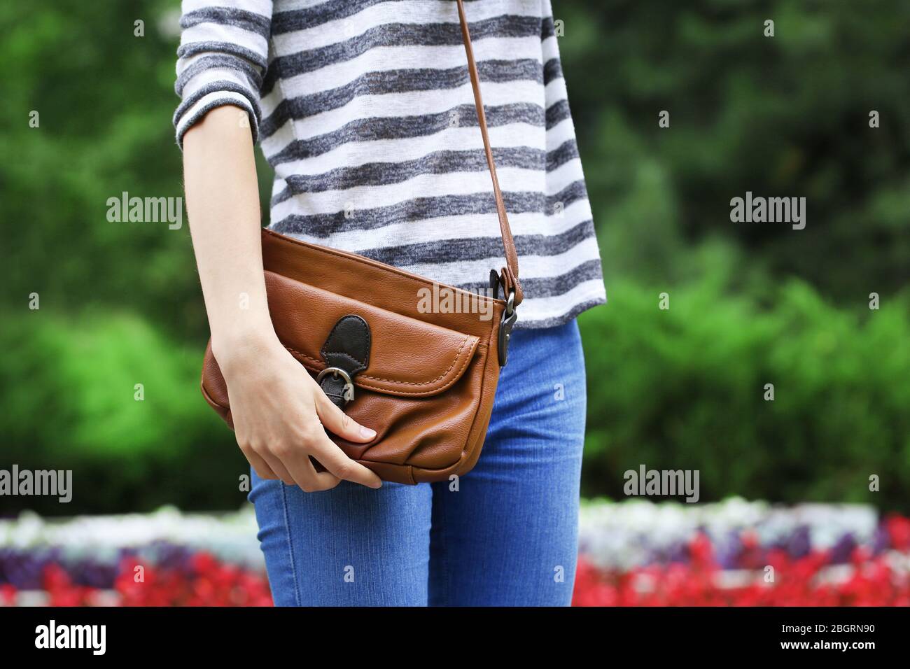 Girl with bag over his shoulder outdoors Stock Photo - Alamy