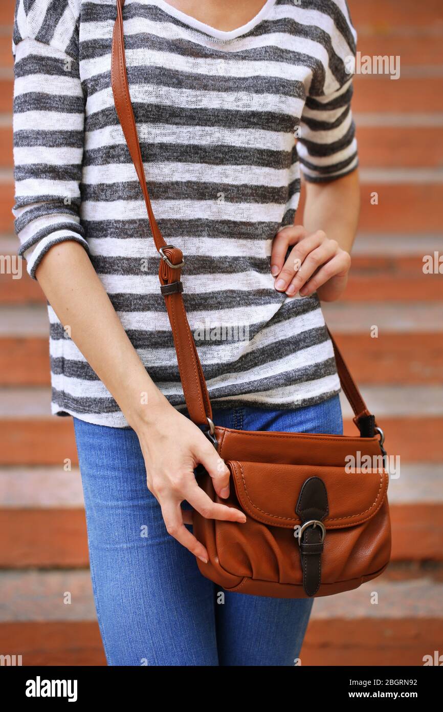 Girl with bag over his shoulder outdoors Stock Photo - Alamy