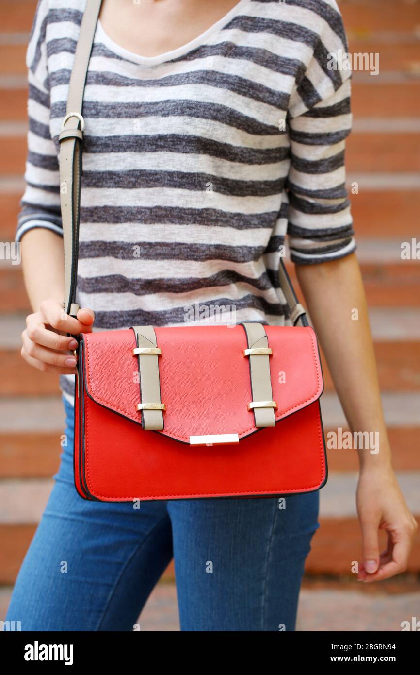 Girl with bag over his shoulder outdoors Stock Photo - Alamy