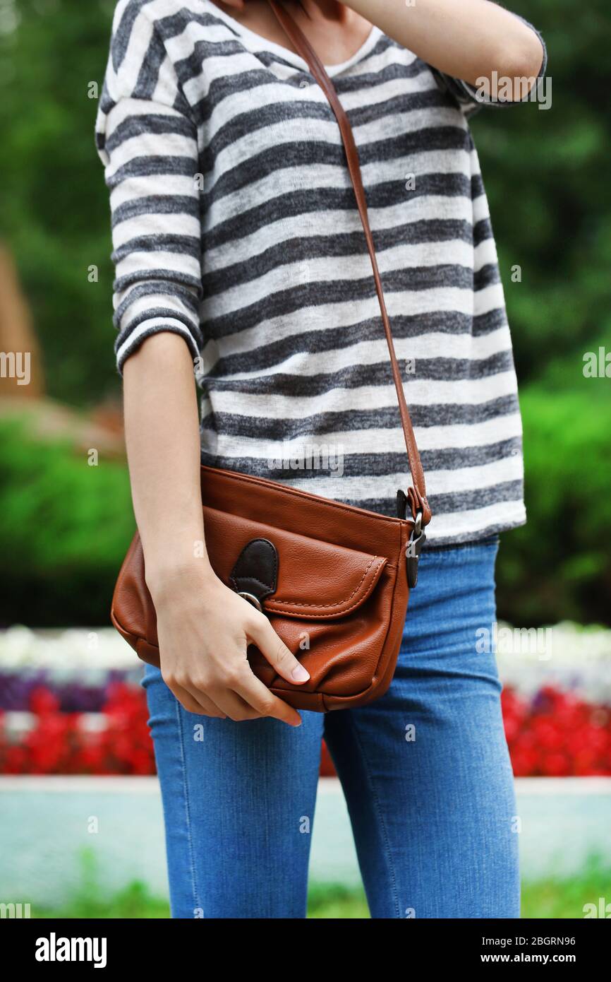 Girl with bag over his shoulder outdoors Stock Photo - Alamy