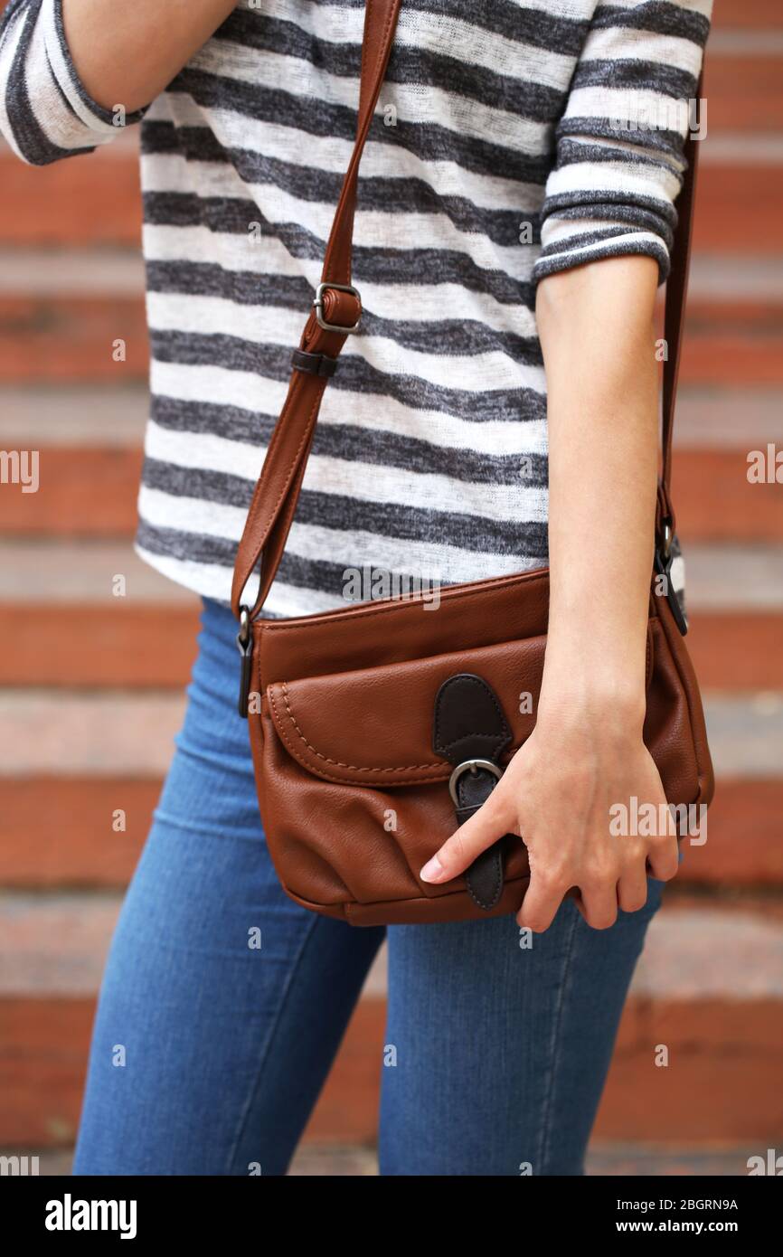 Girl with bag over his shoulder outdoors Stock Photo - Alamy