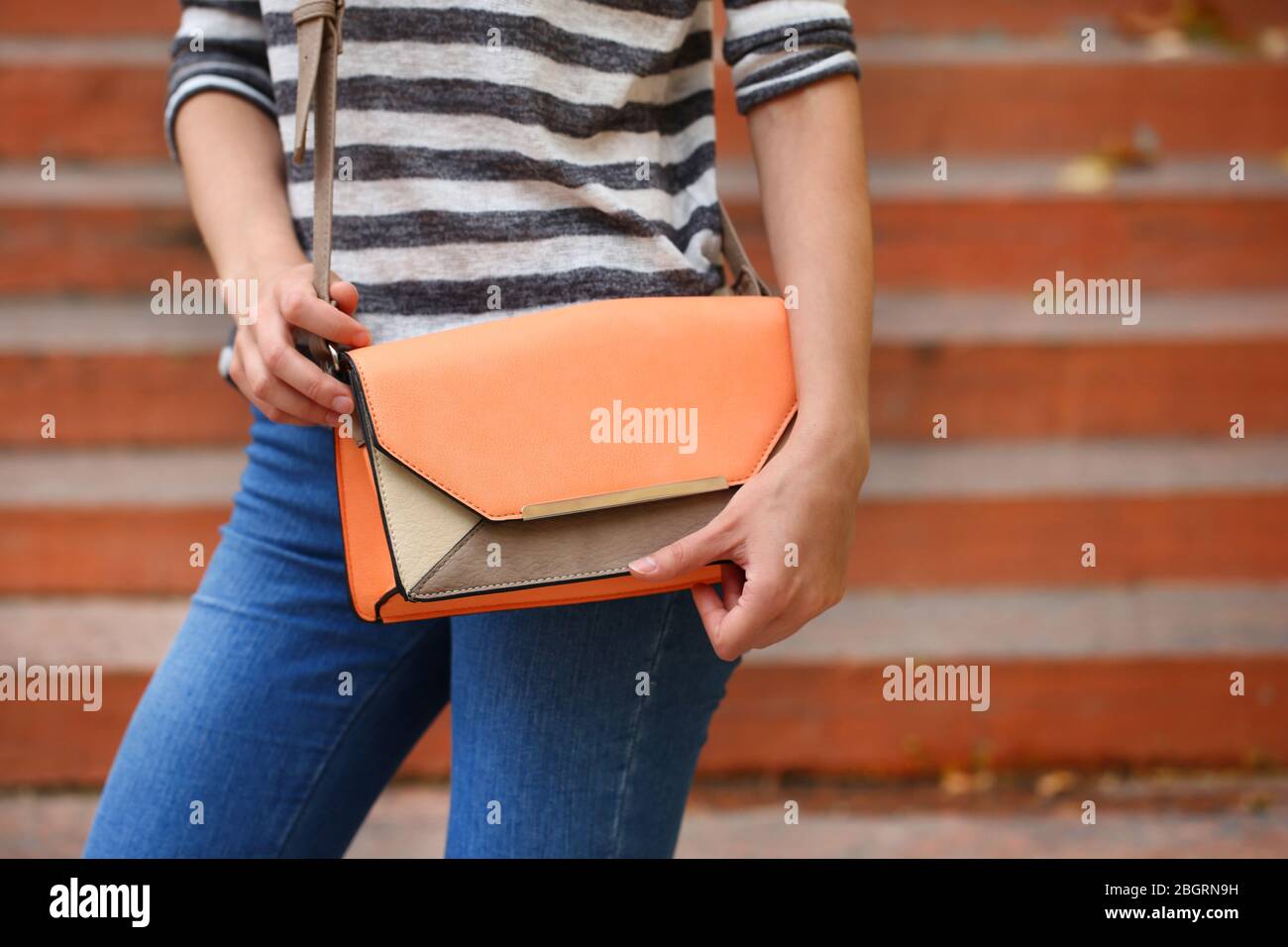 Girl with bag over his shoulder outdoors Stock Photo - Alamy