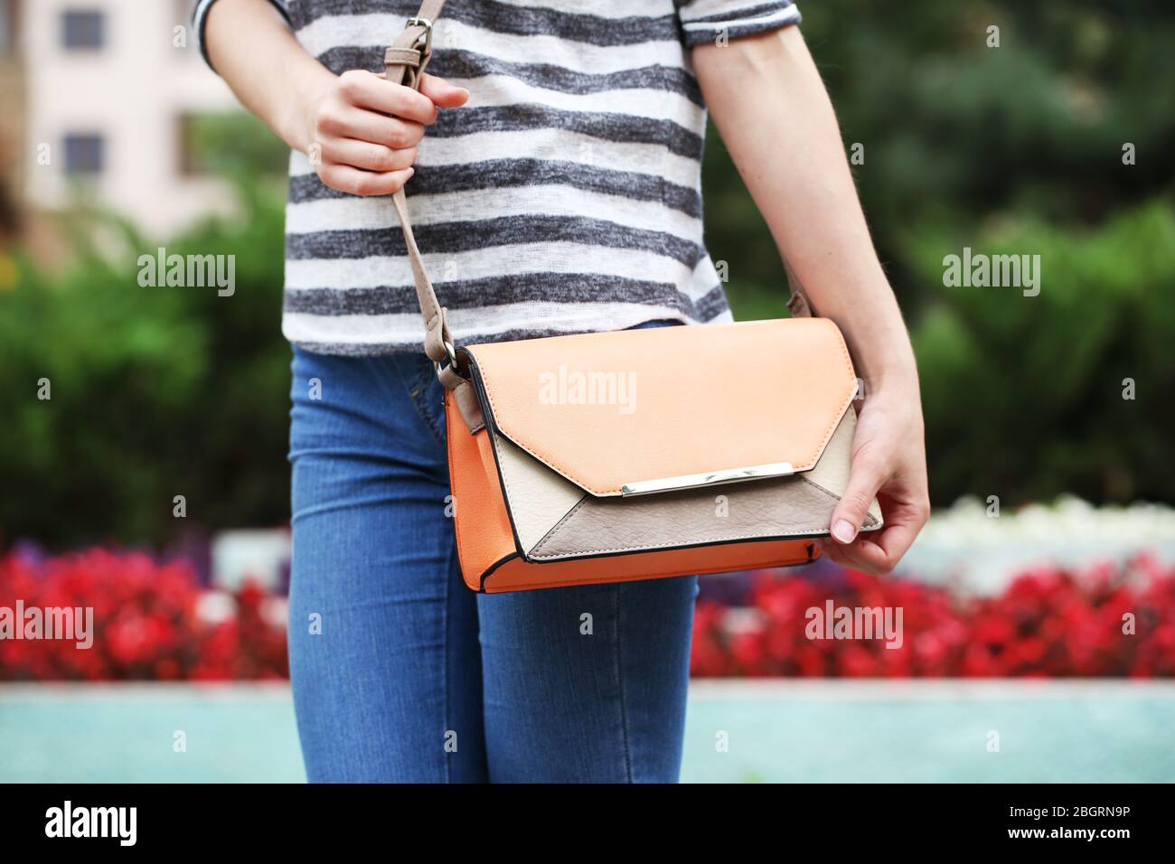 Girl with bag over his shoulder outdoors Stock Photo - Alamy
