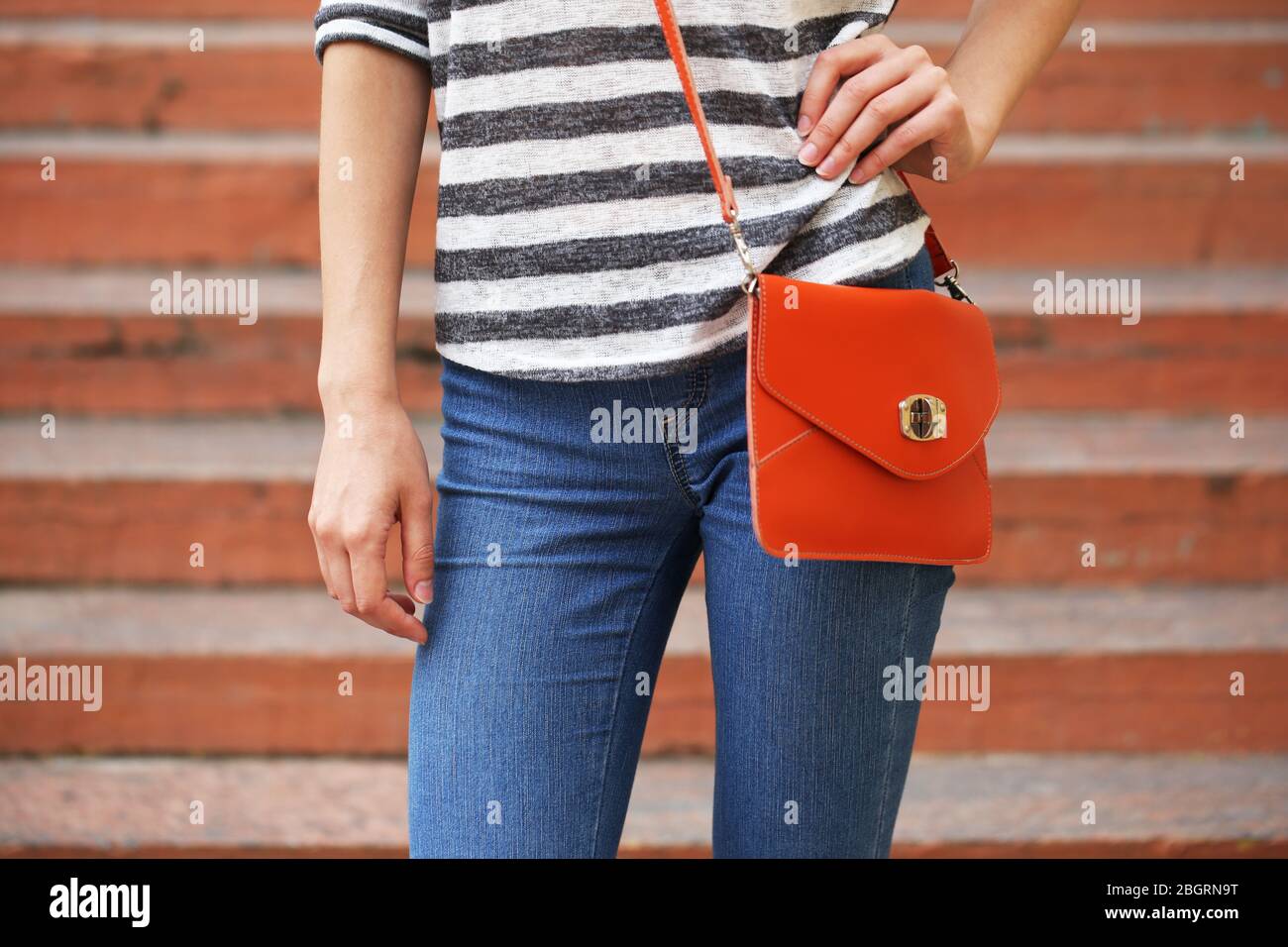 Girl with bag over his shoulder outdoors Stock Photo - Alamy