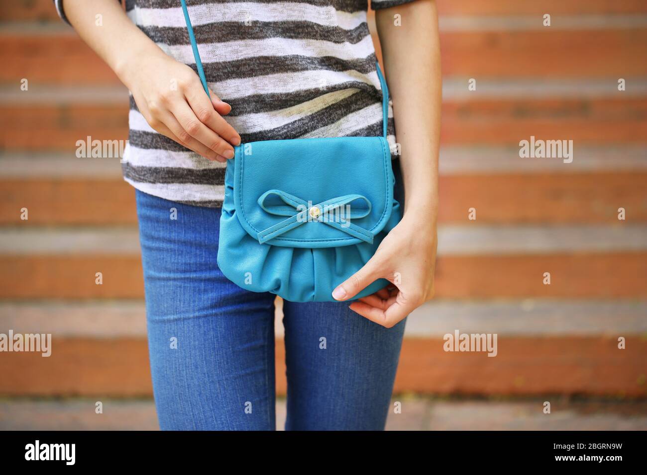 Girl with bag over his shoulder outdoors Stock Photo - Alamy