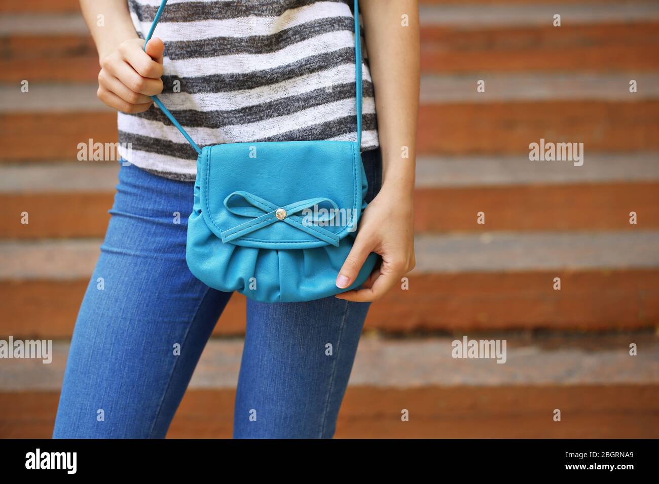 Girl with bag over his shoulder outdoors Stock Photo - Alamy