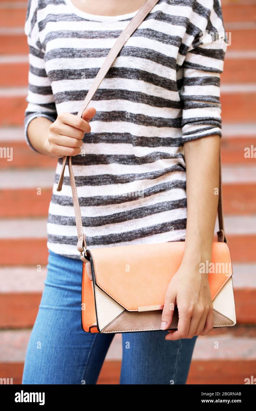 Girl with bag over his shoulder outdoors Stock Photo - Alamy